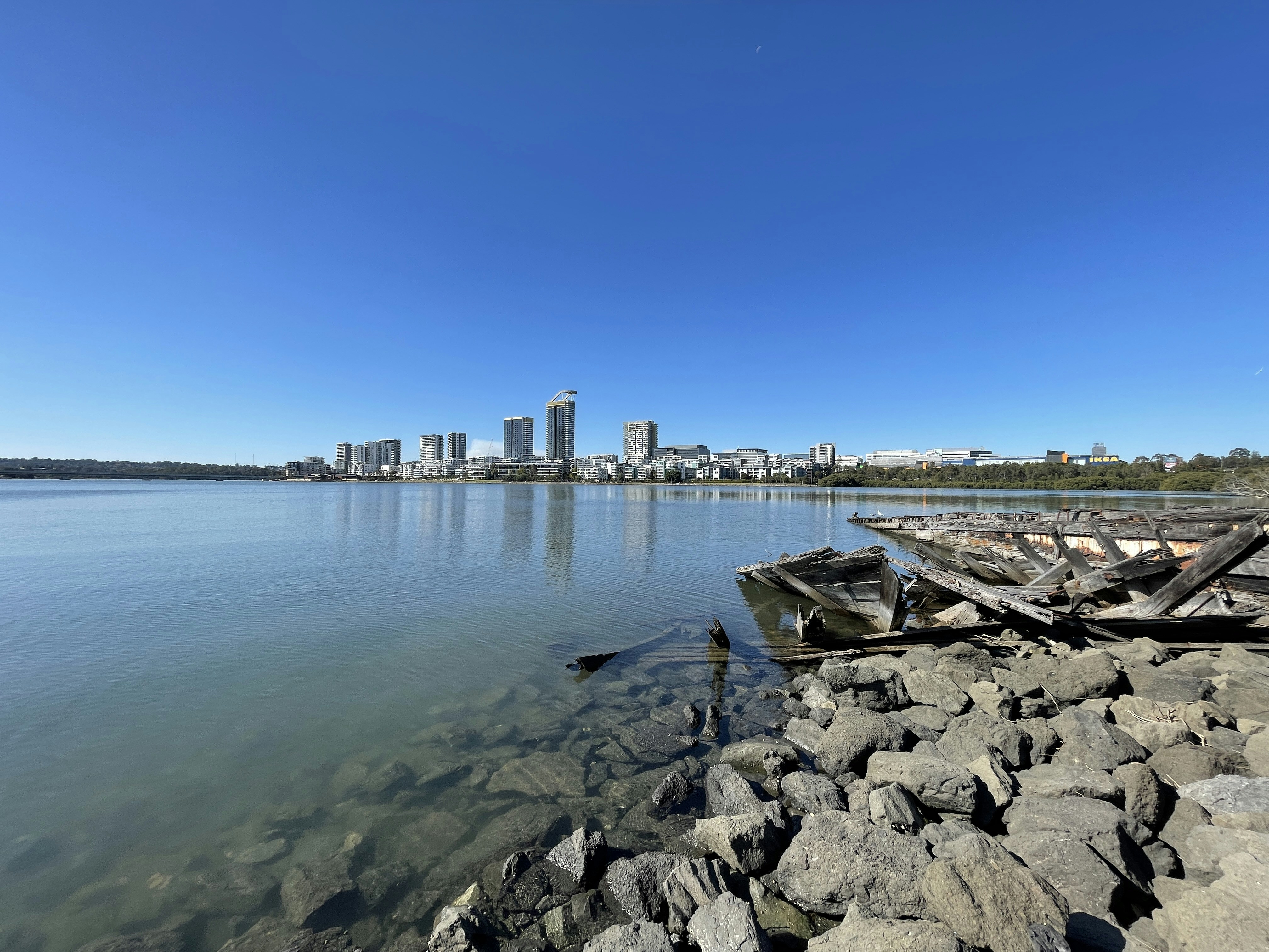 body of water near city buildings during daytime