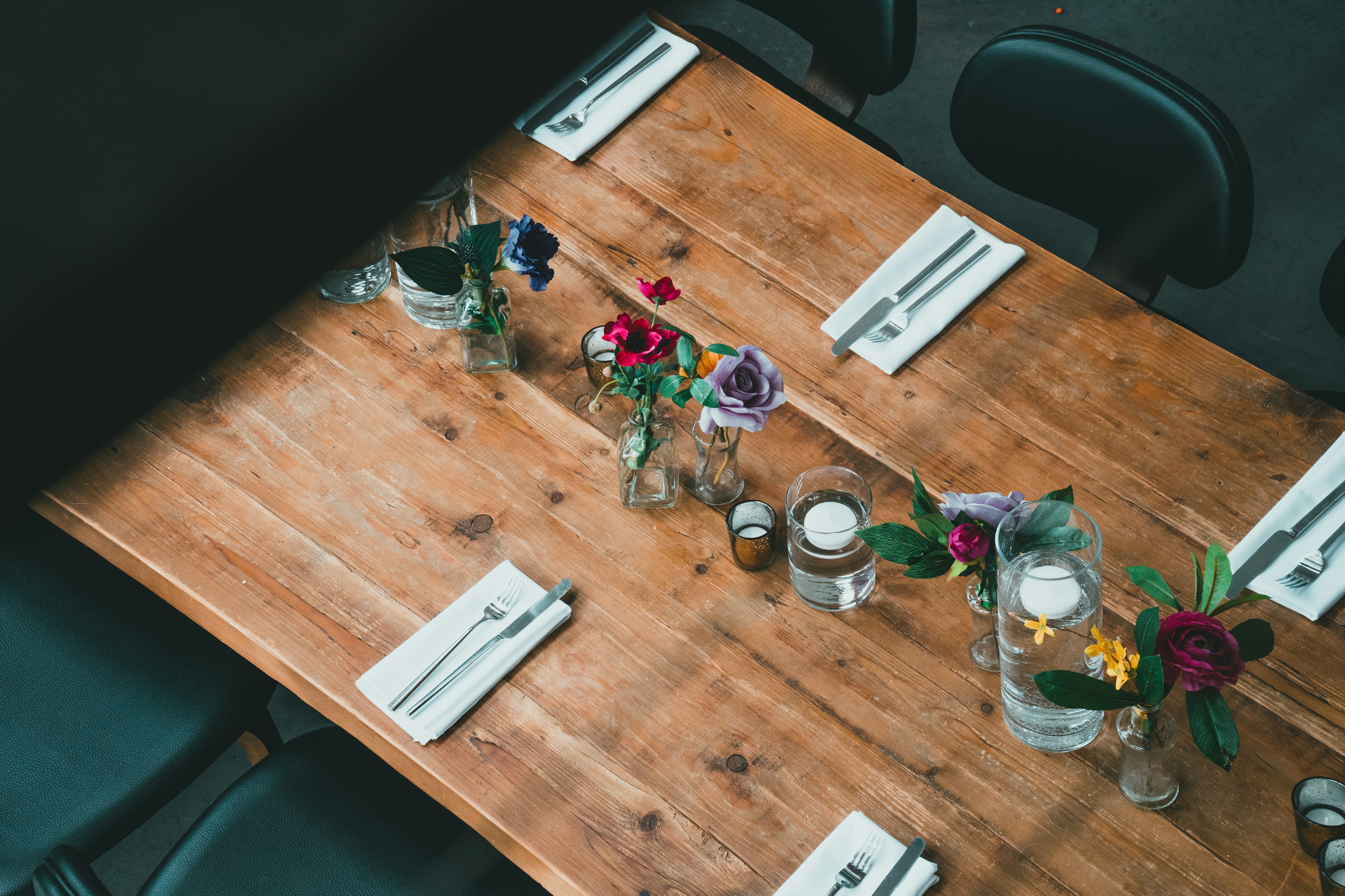 white and pink flowers on brown wooden table