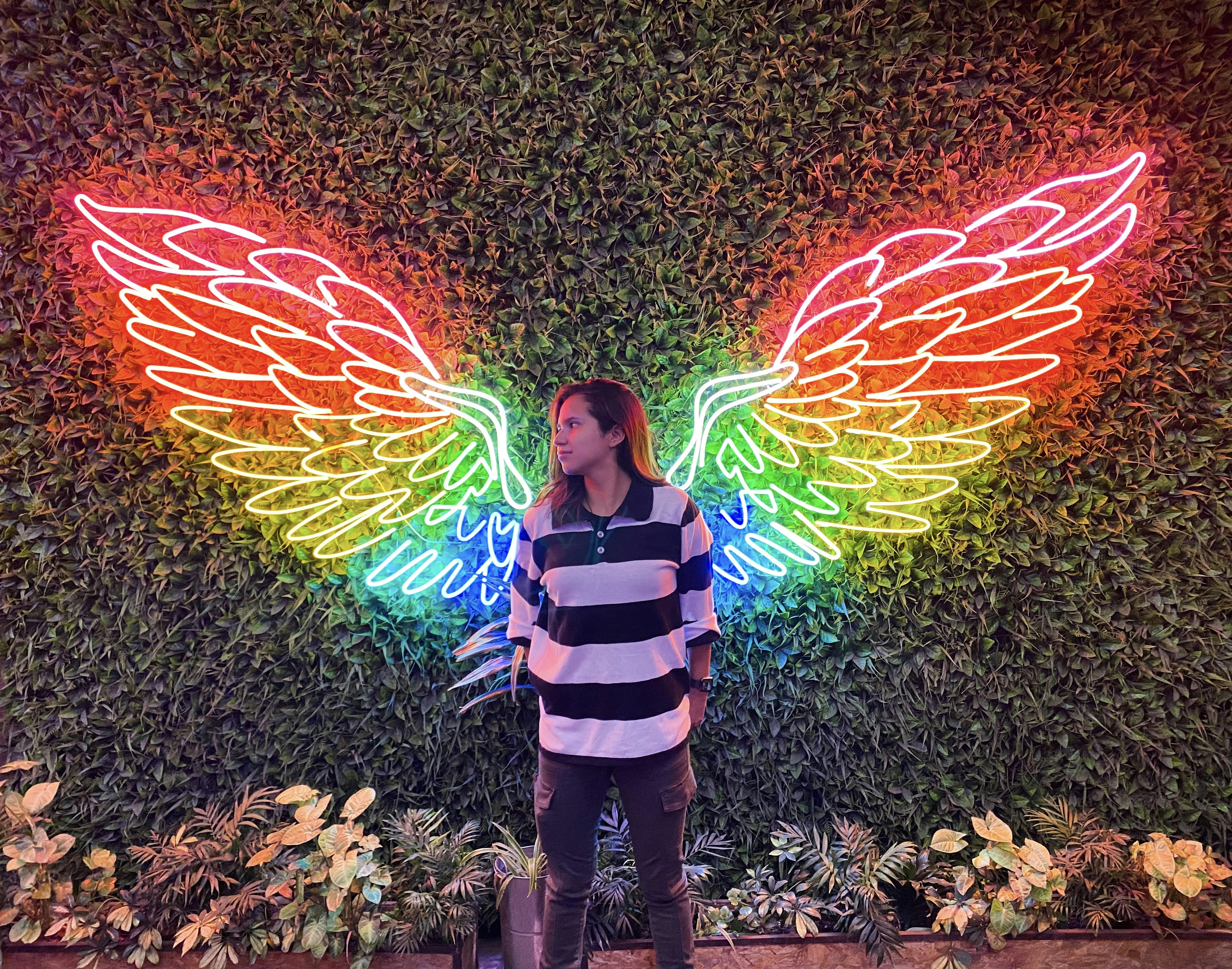 Chromatic Neon Wings: A Striped Portrait Before Living Graffiti