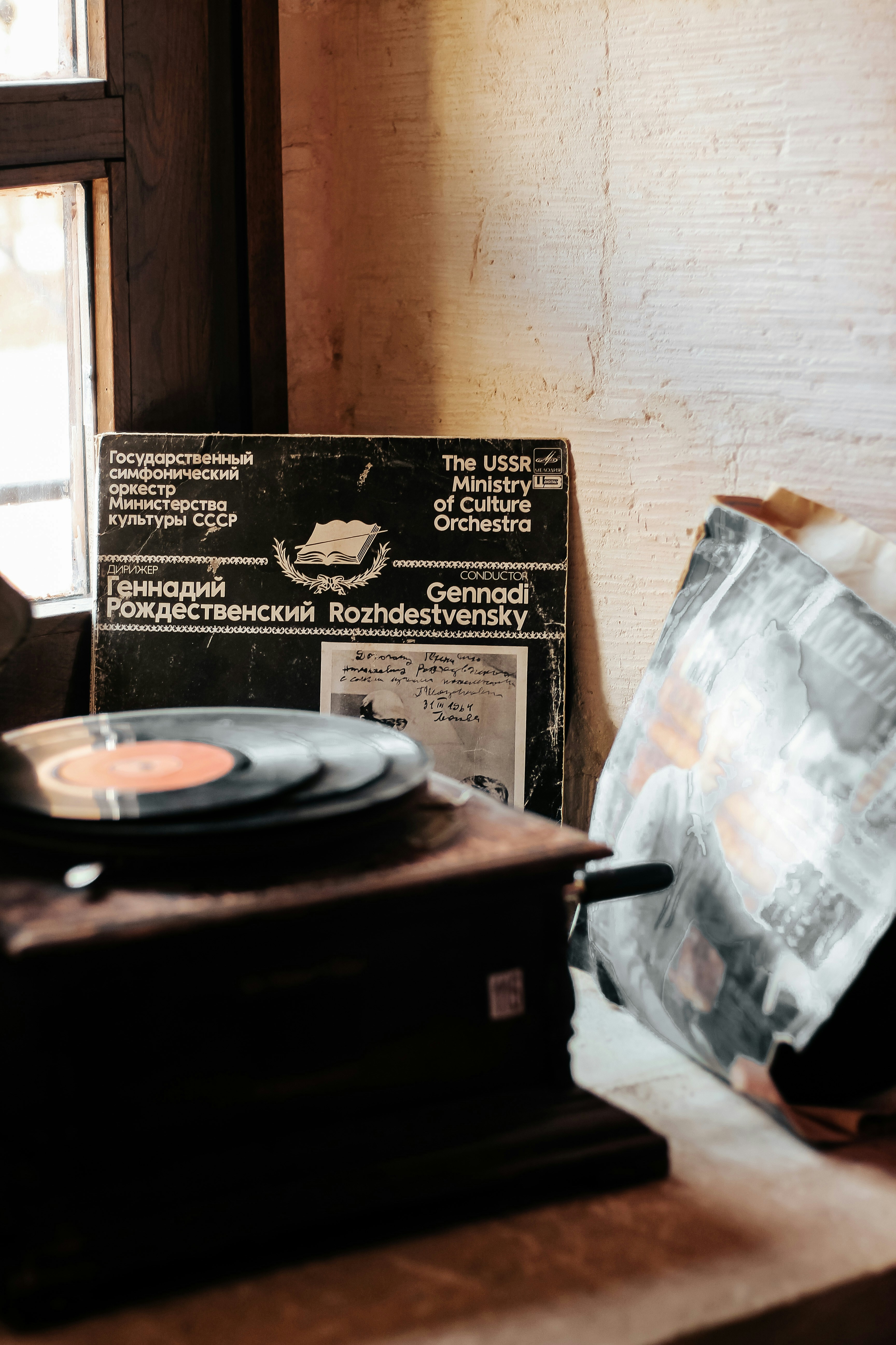 Vinyl Echoes: A Vintage Turntable Guarded by a Soviet Poster