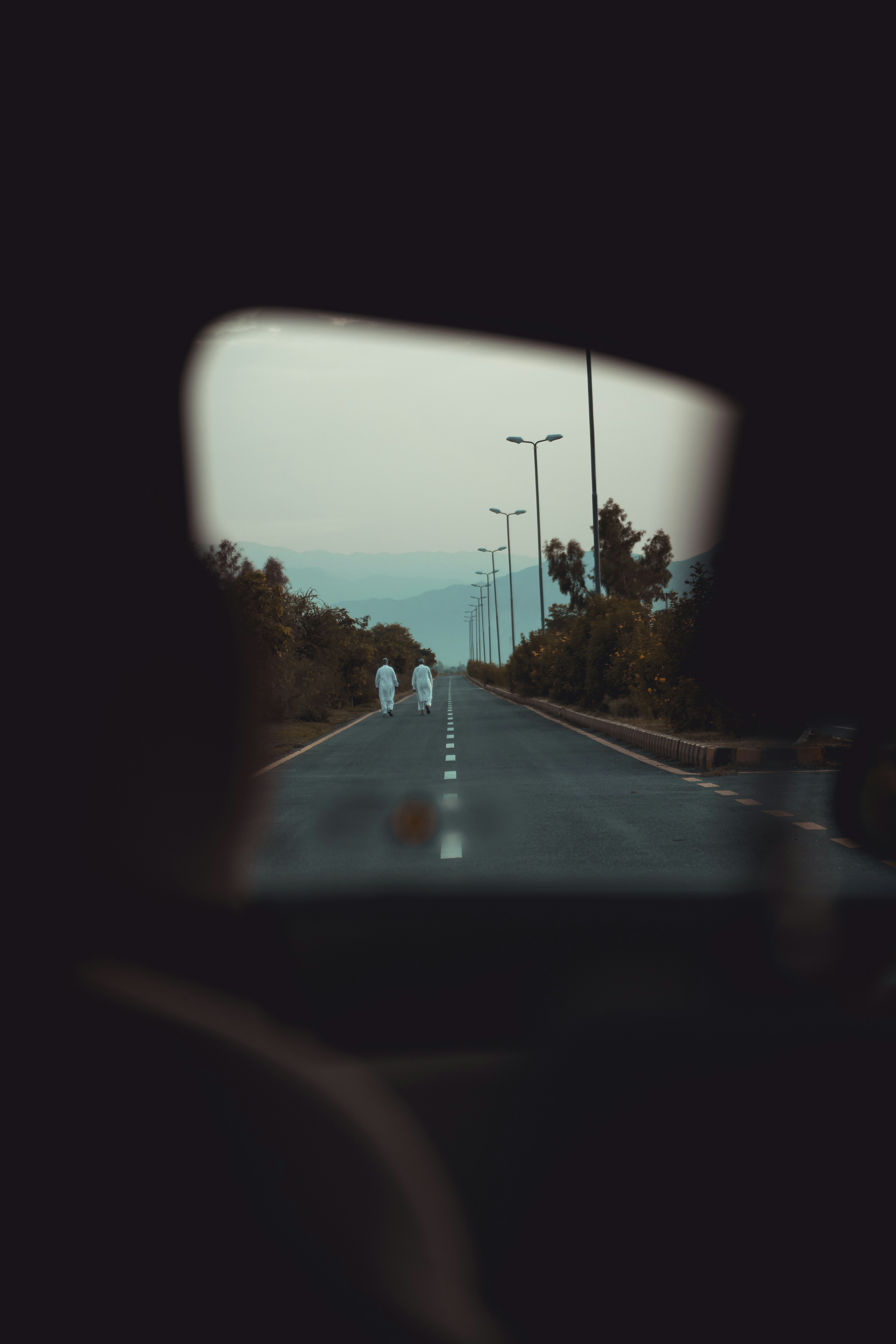 White-Clad Silhouettes on a Quiet Highway