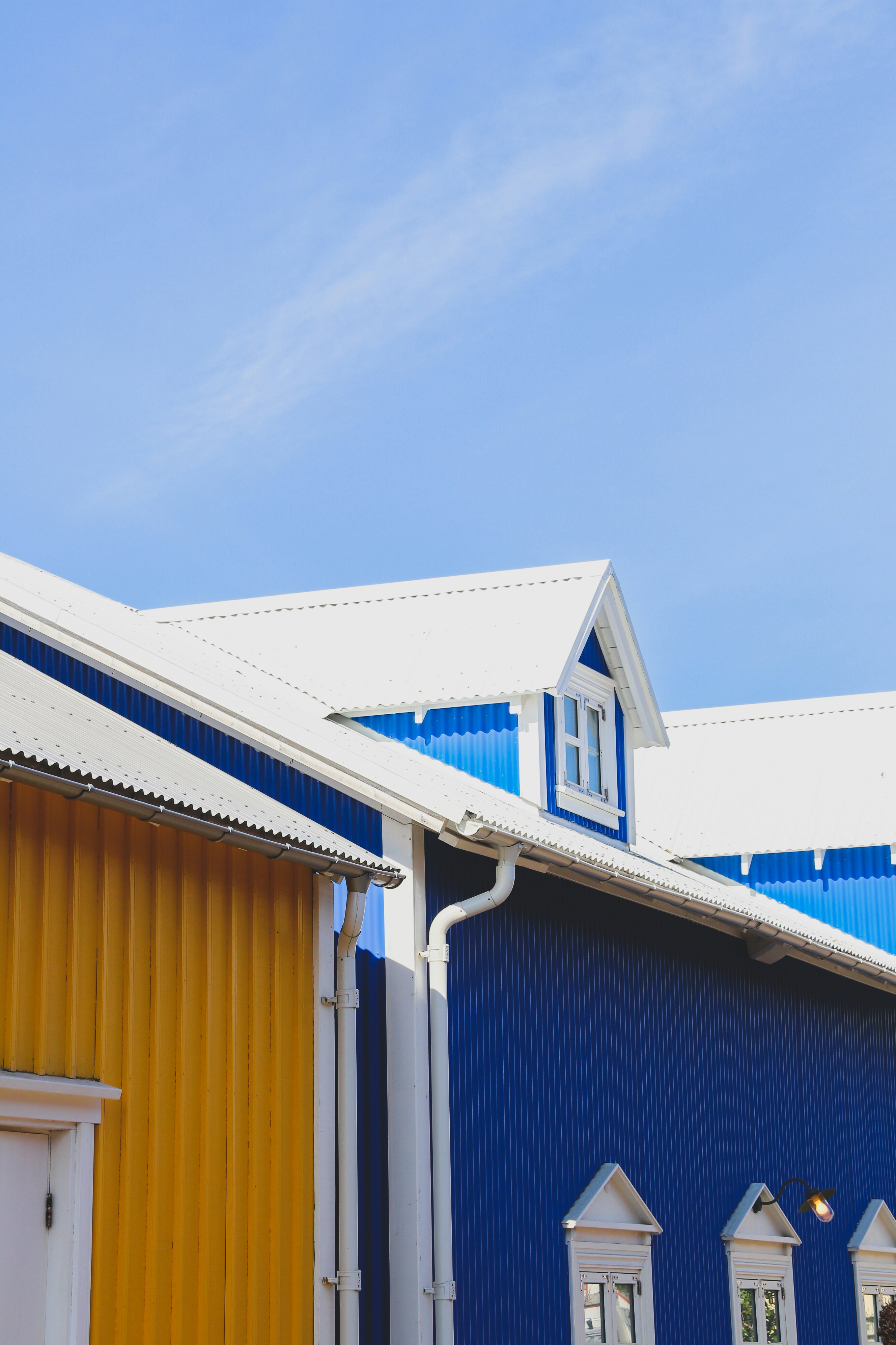 blue and brown wooden building under blue sky during daytime