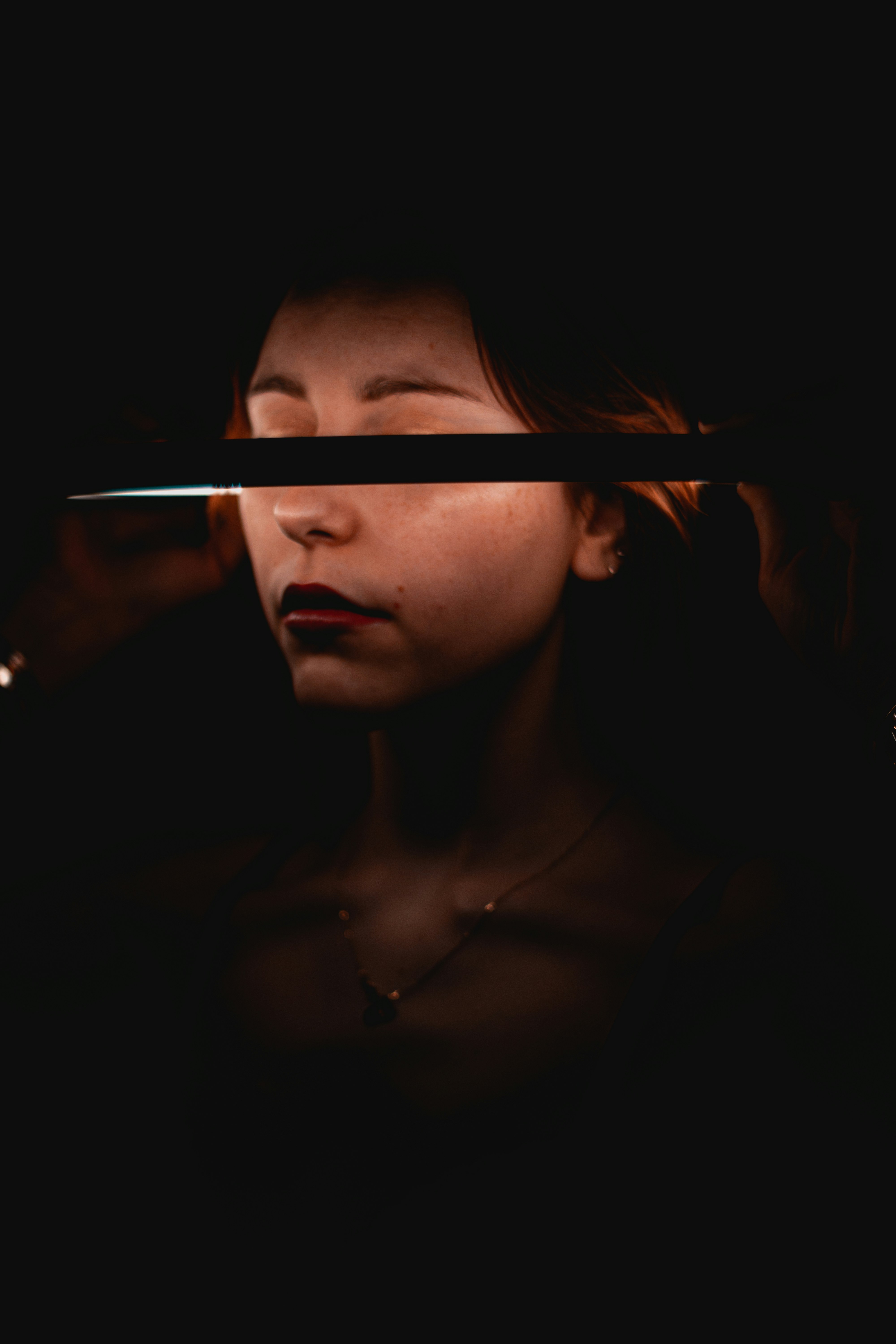 Veiled Gaze: A Half-Visible Portrait in Stilled Darkness