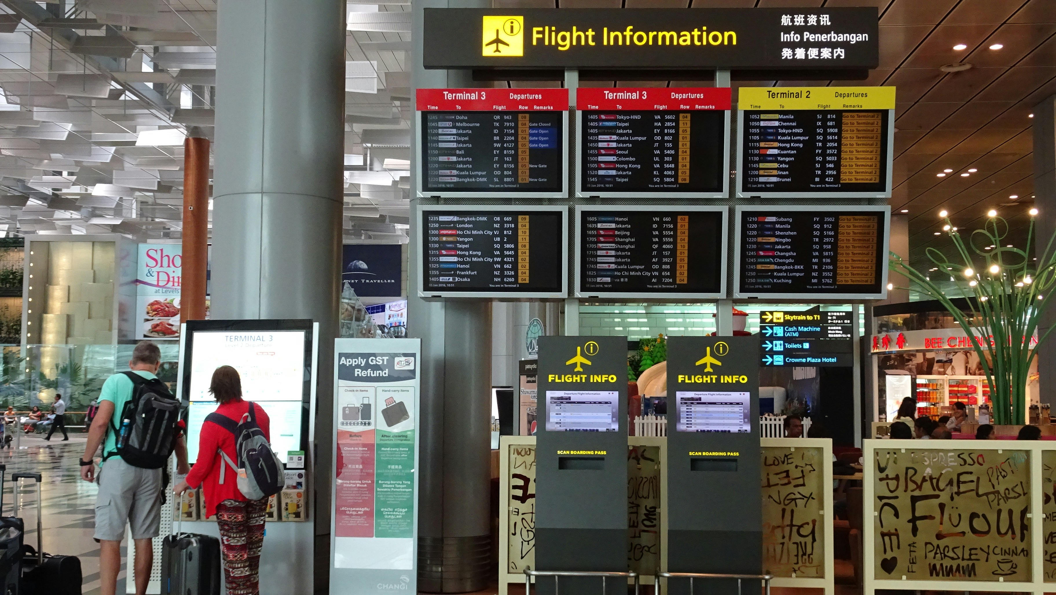 Changi Airport Terminal Information | woman in red jacket standing near store