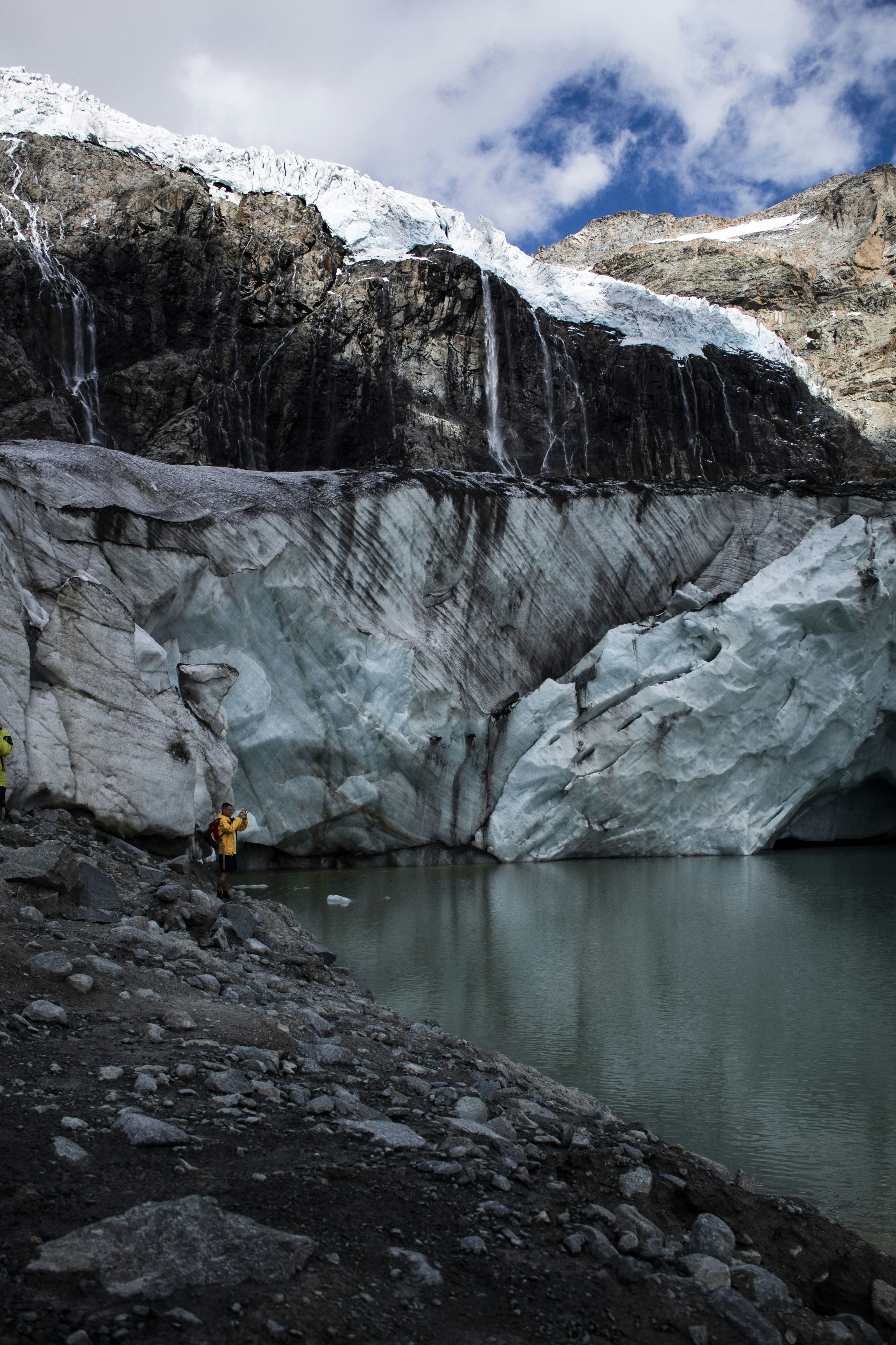 Whispers of Ice: A Climber at the Glacier’s Edge by Turquoise Meltwater