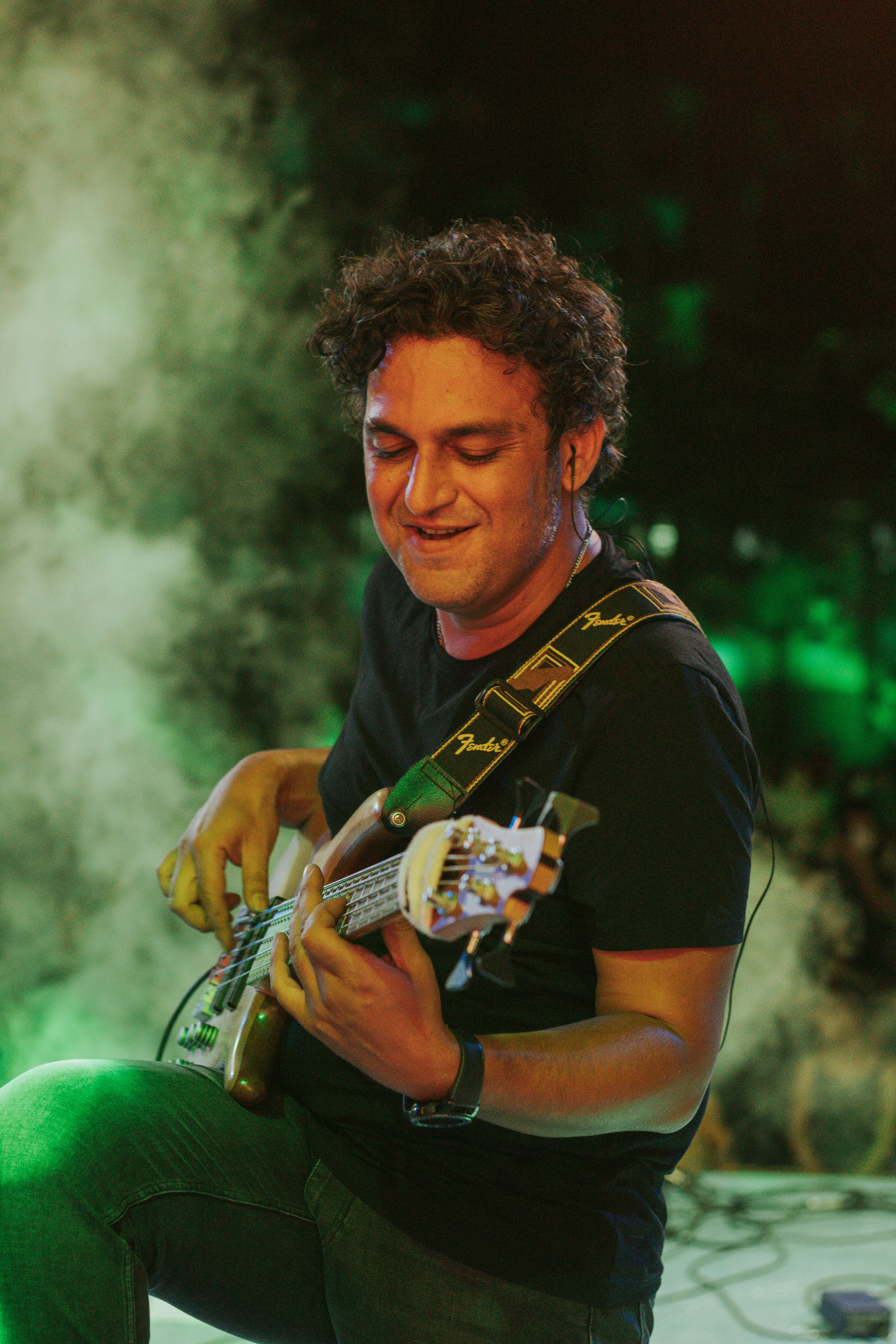 Green Light Serenade: A Guitarist Basks in Fog and Focus