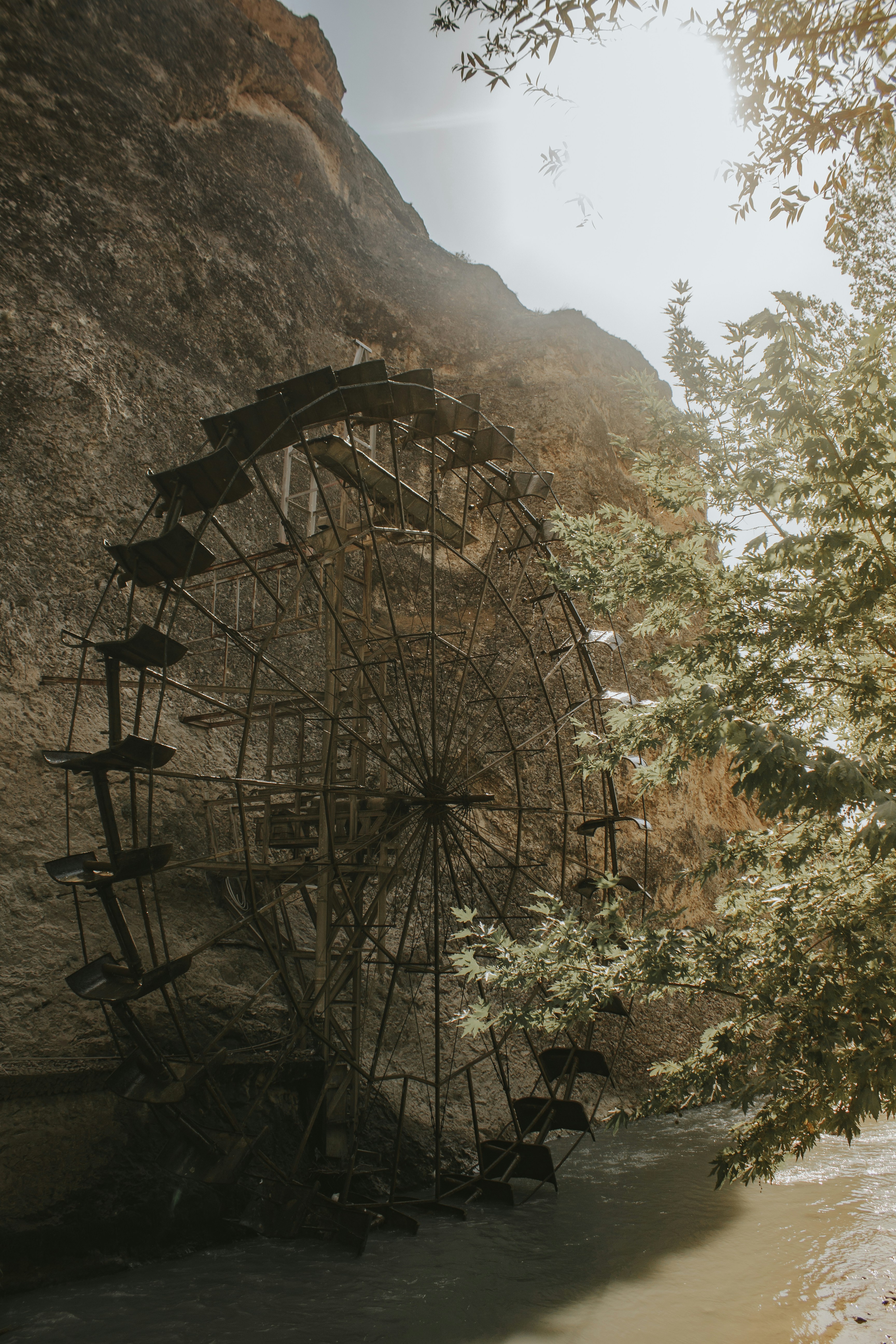 Cliffside Water Wheel in Dappled Light