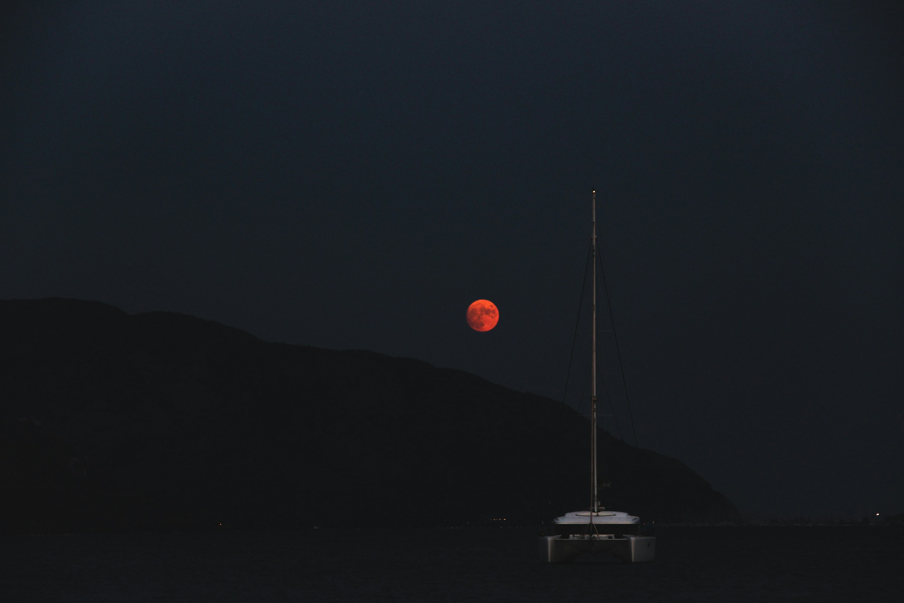 Red Moon Over the Quiet Marina