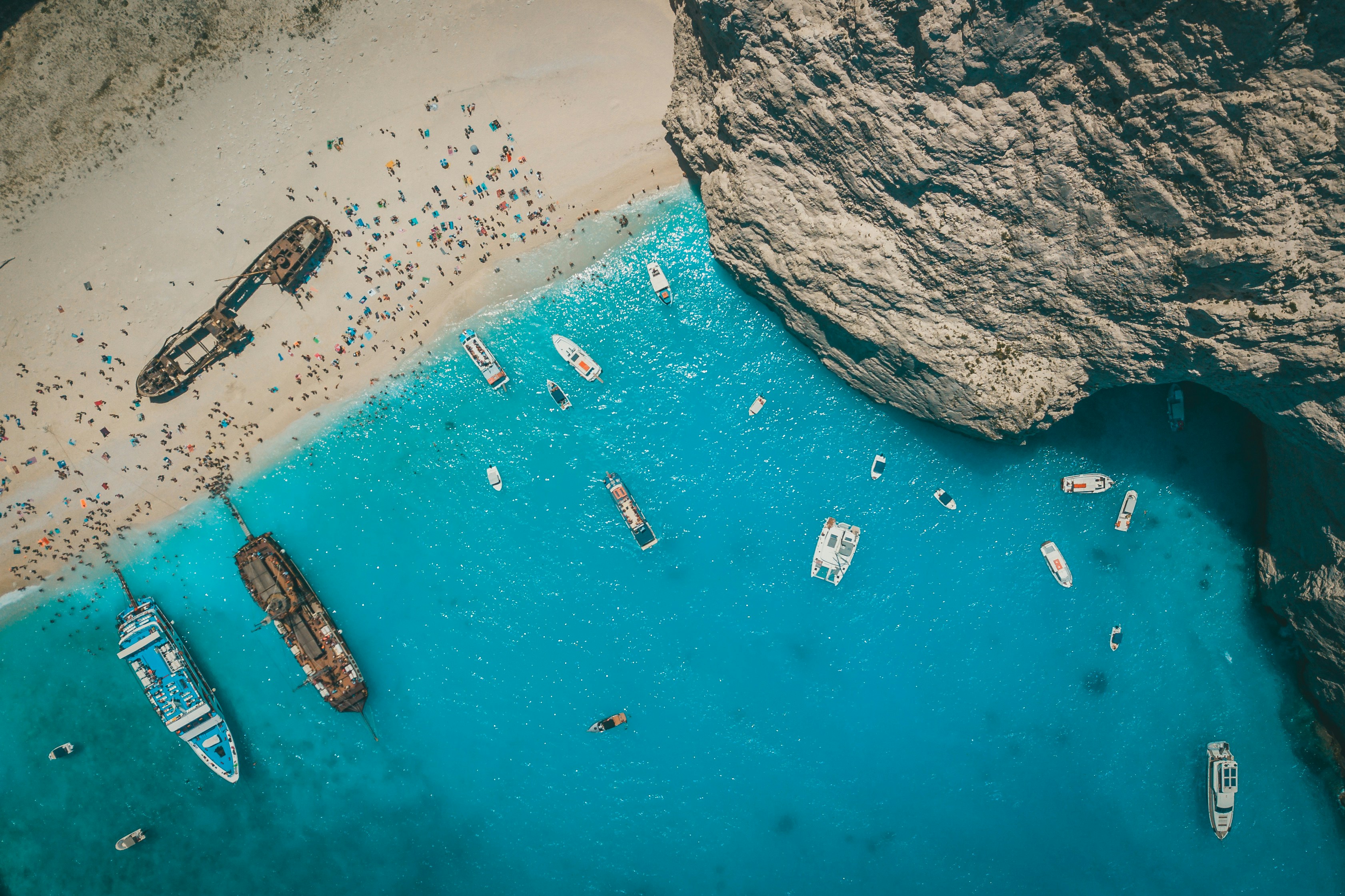 Azure Cove: Aerial Caravan of Boats Adrift in Turquoise Reefs