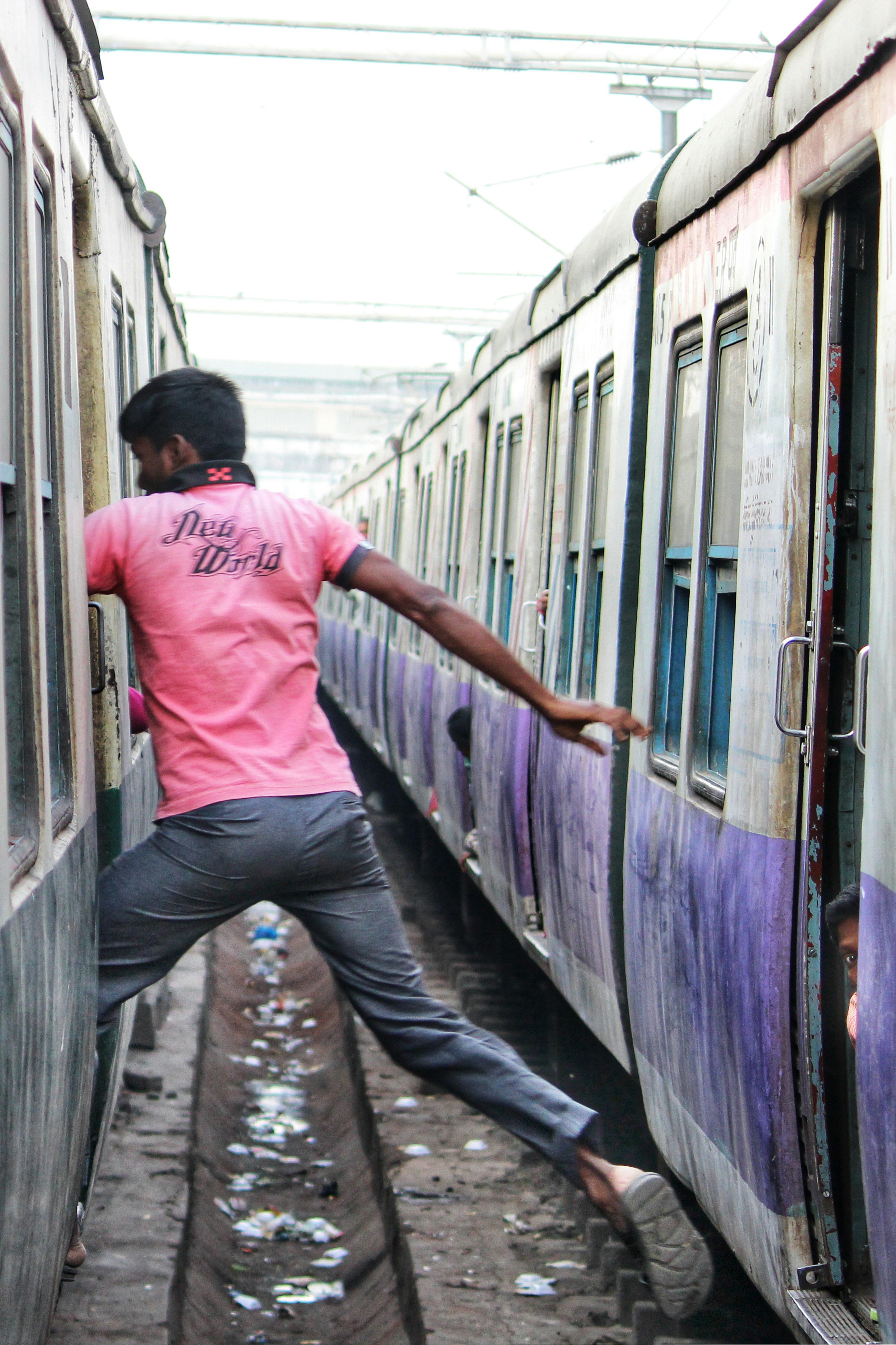 Leap Between Rails: A Bold Mid-Air Moment on a Narrow Platform