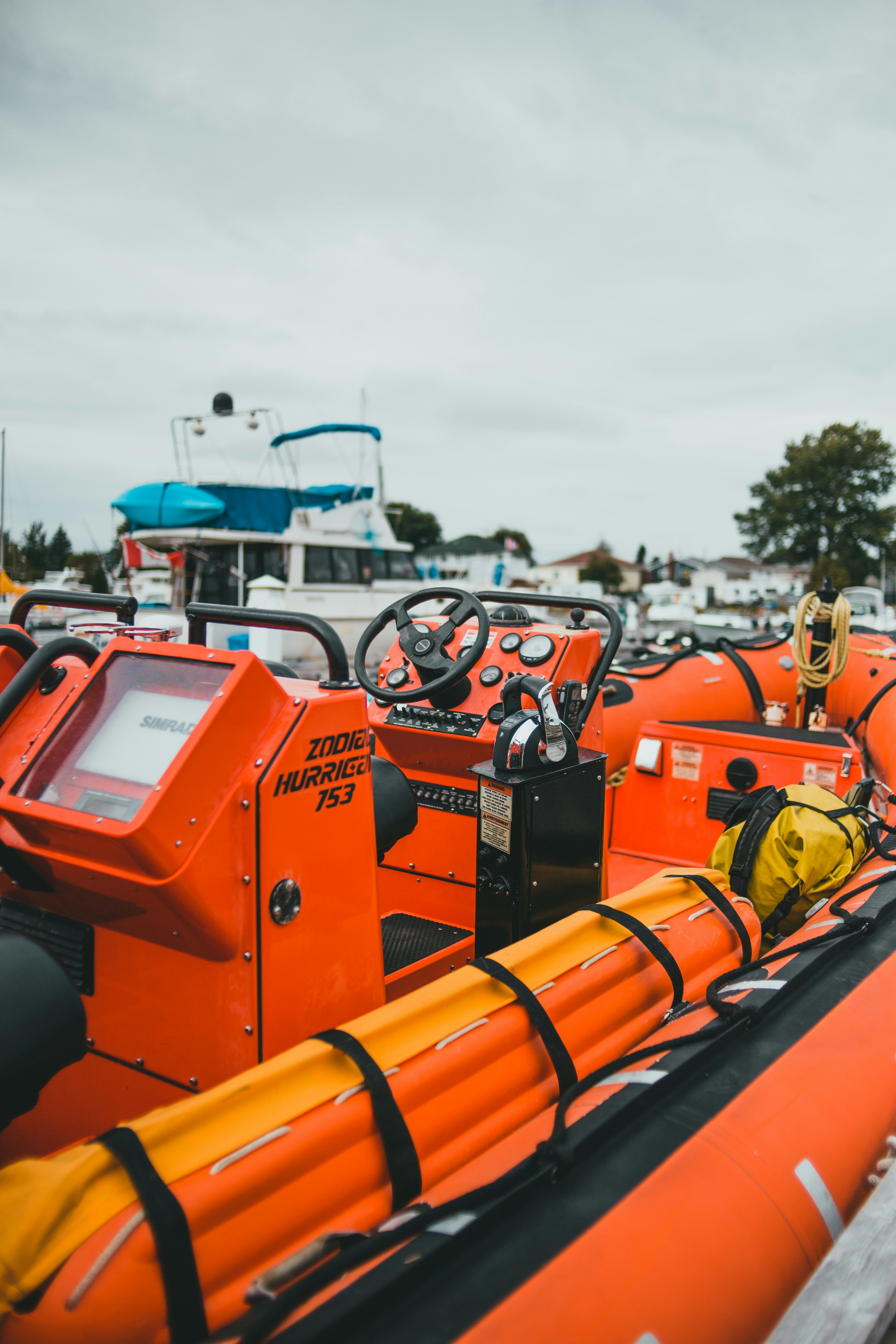 Orange Lifelines at the Marina: A Crew of Rigid Joys