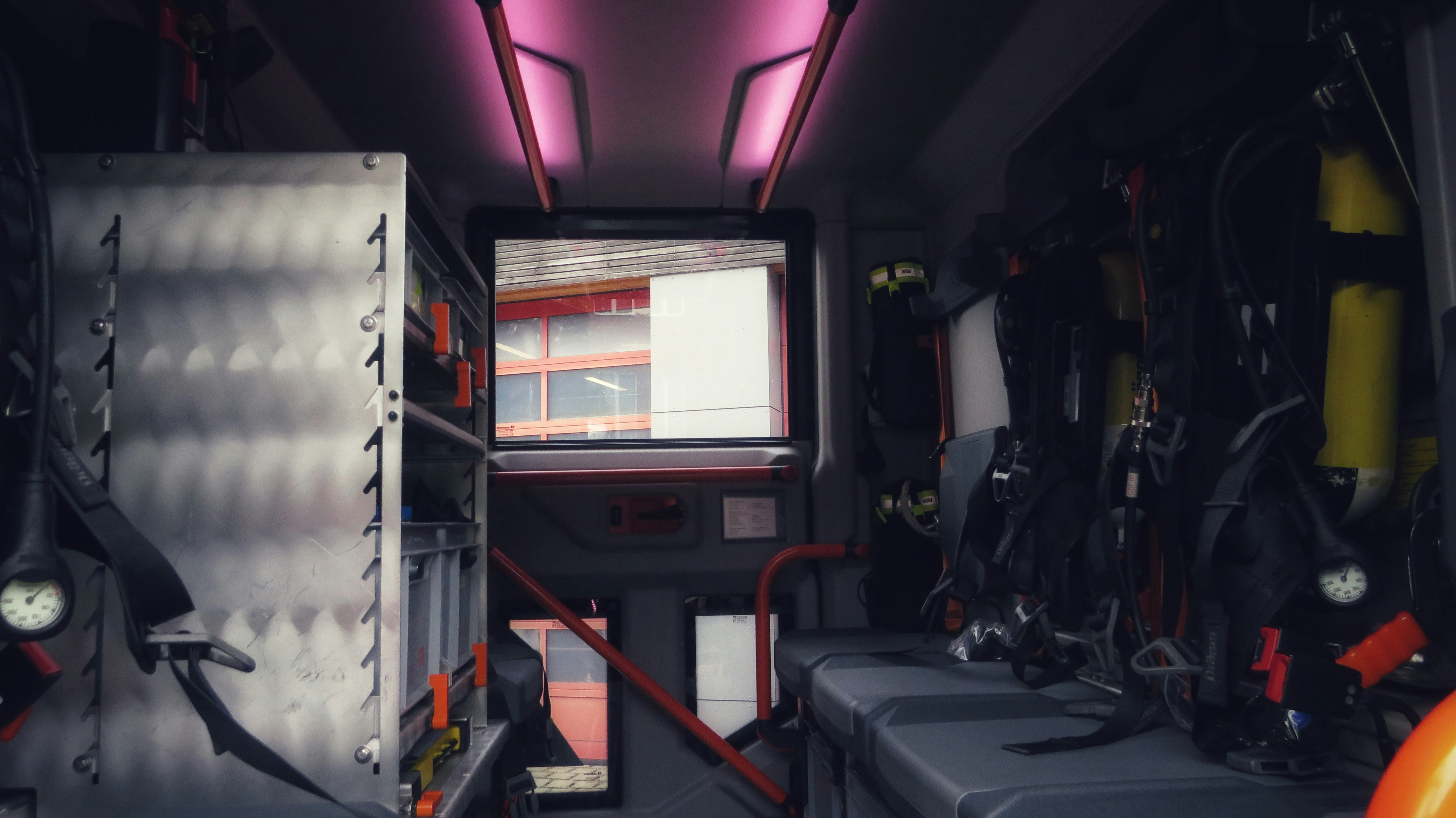 Gear-Laden Fire Rescue Cabin Framed by a Narrow Back Window