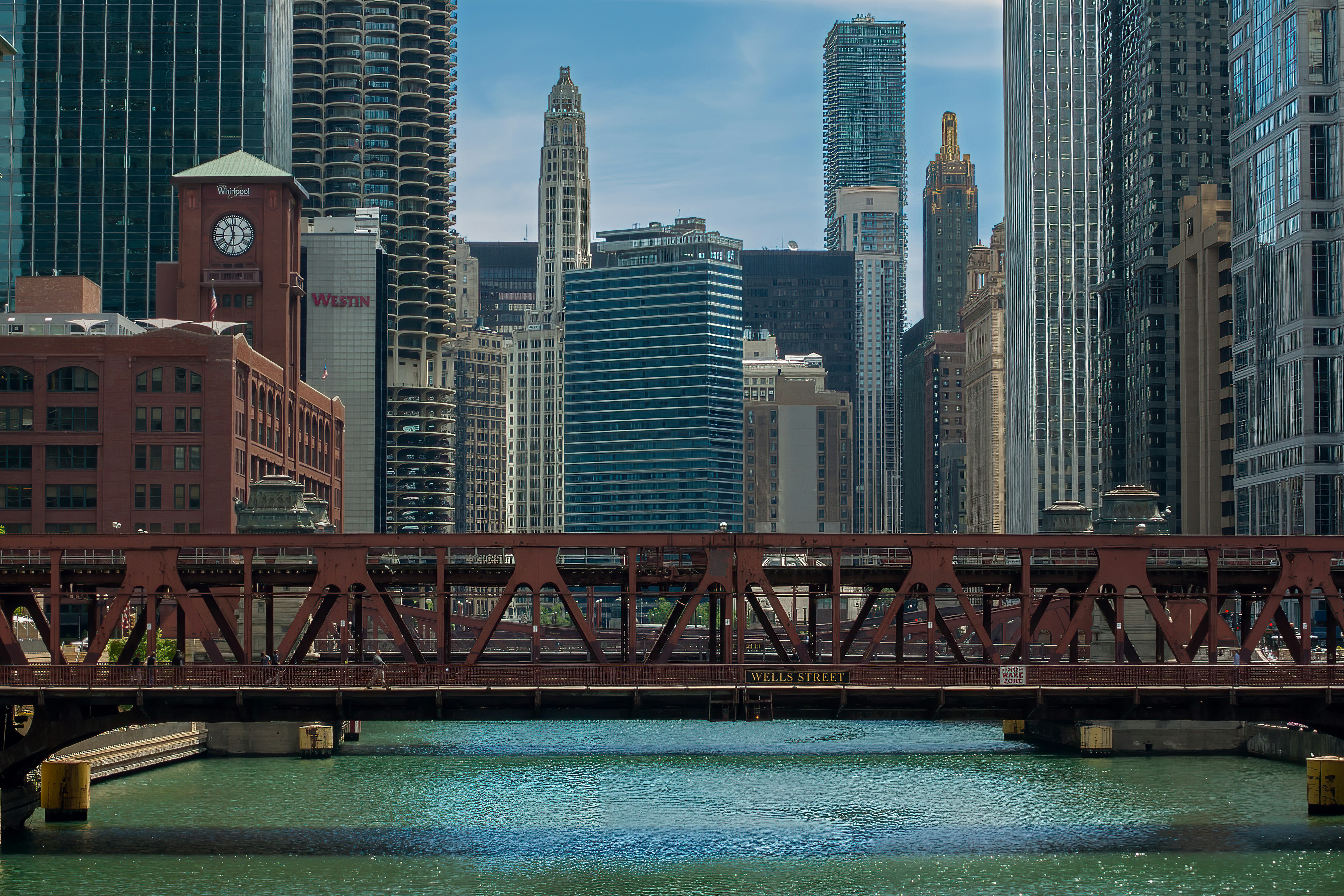Brown bridge over body of water near high rise buildings during daytime ...