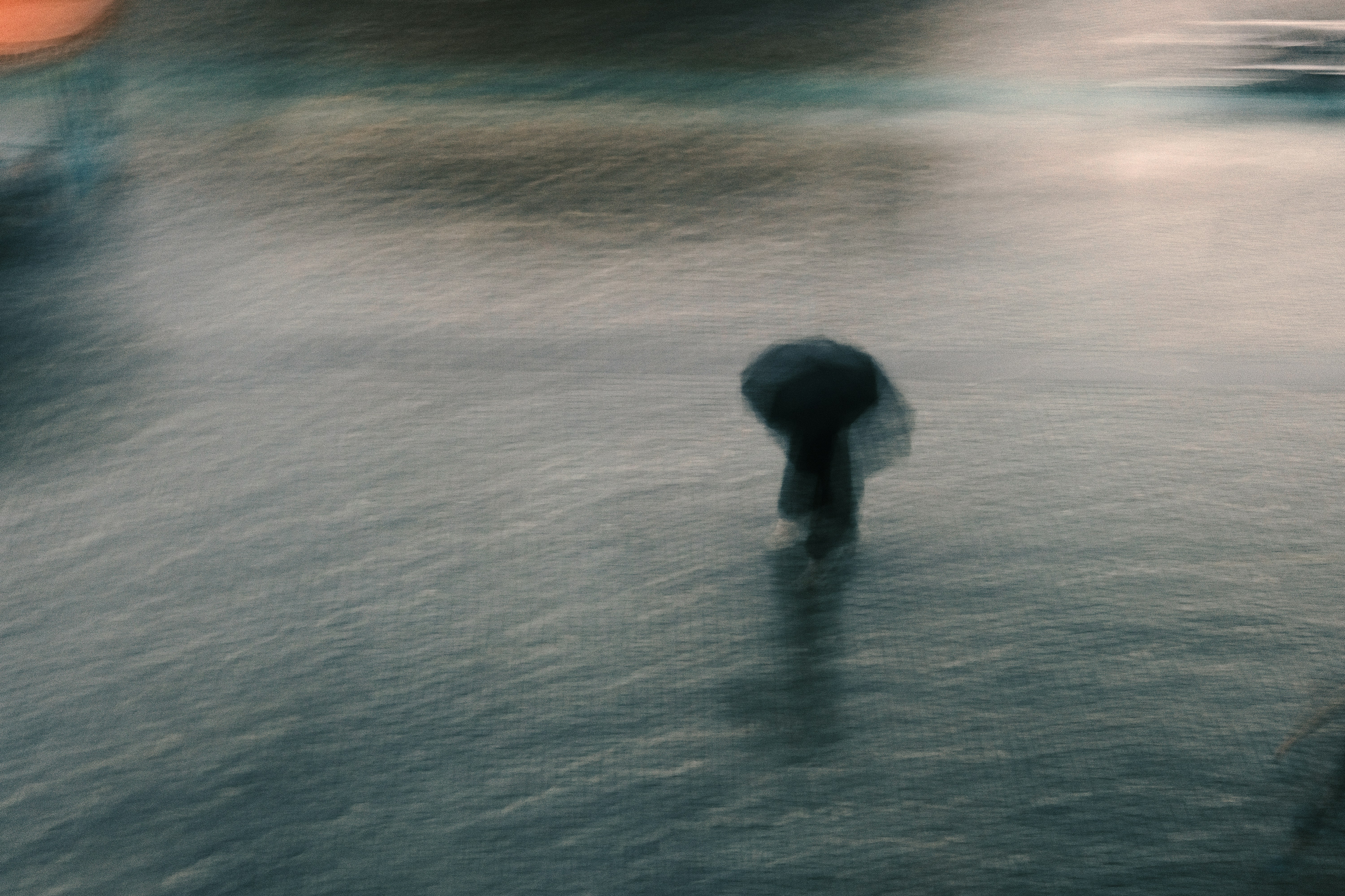 Blurred Sentinel: A Lonely Umbrella Emerges from Icy Stillness