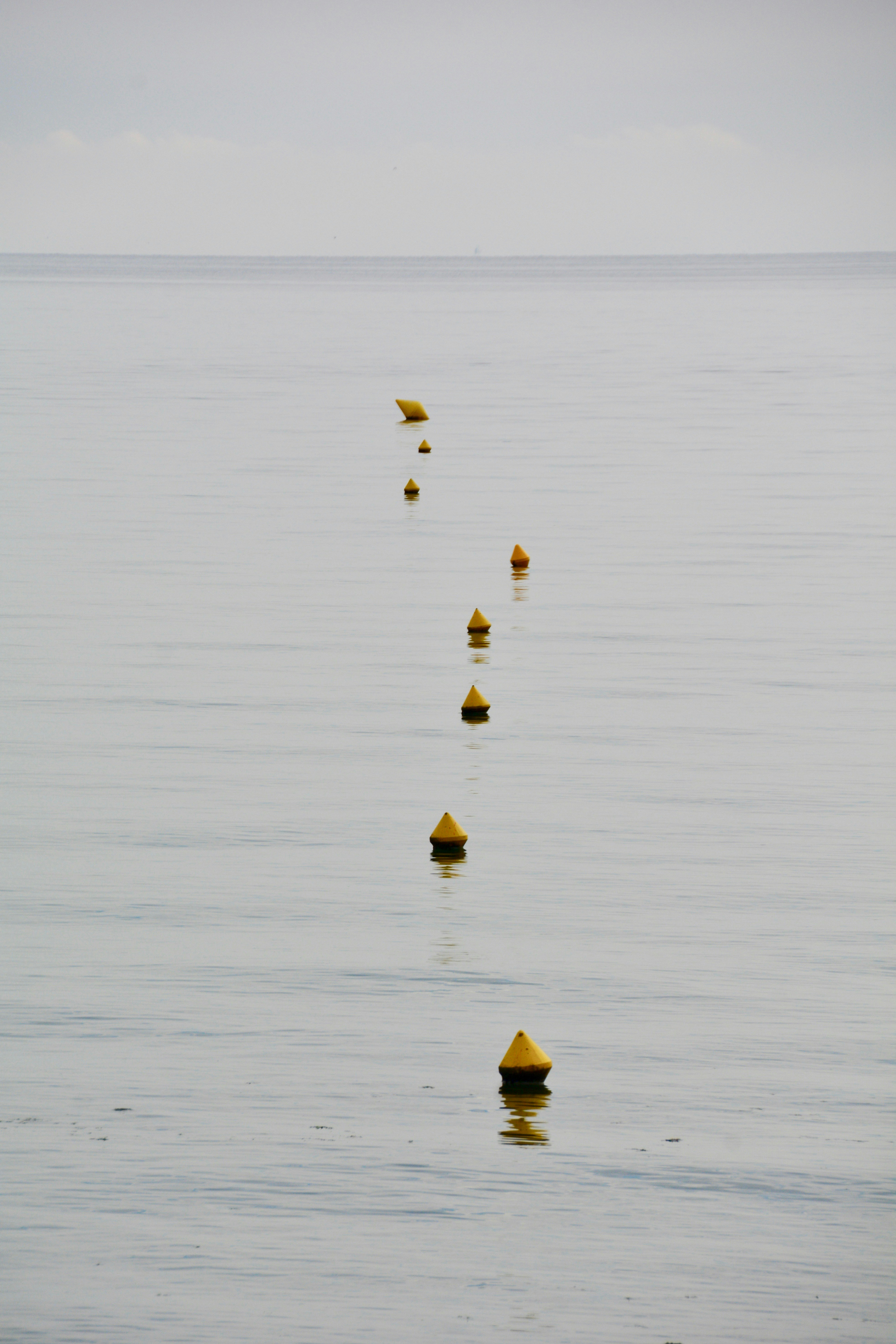 Buoy Trail Across a Glassy Sea: A Minimalist Seascape
