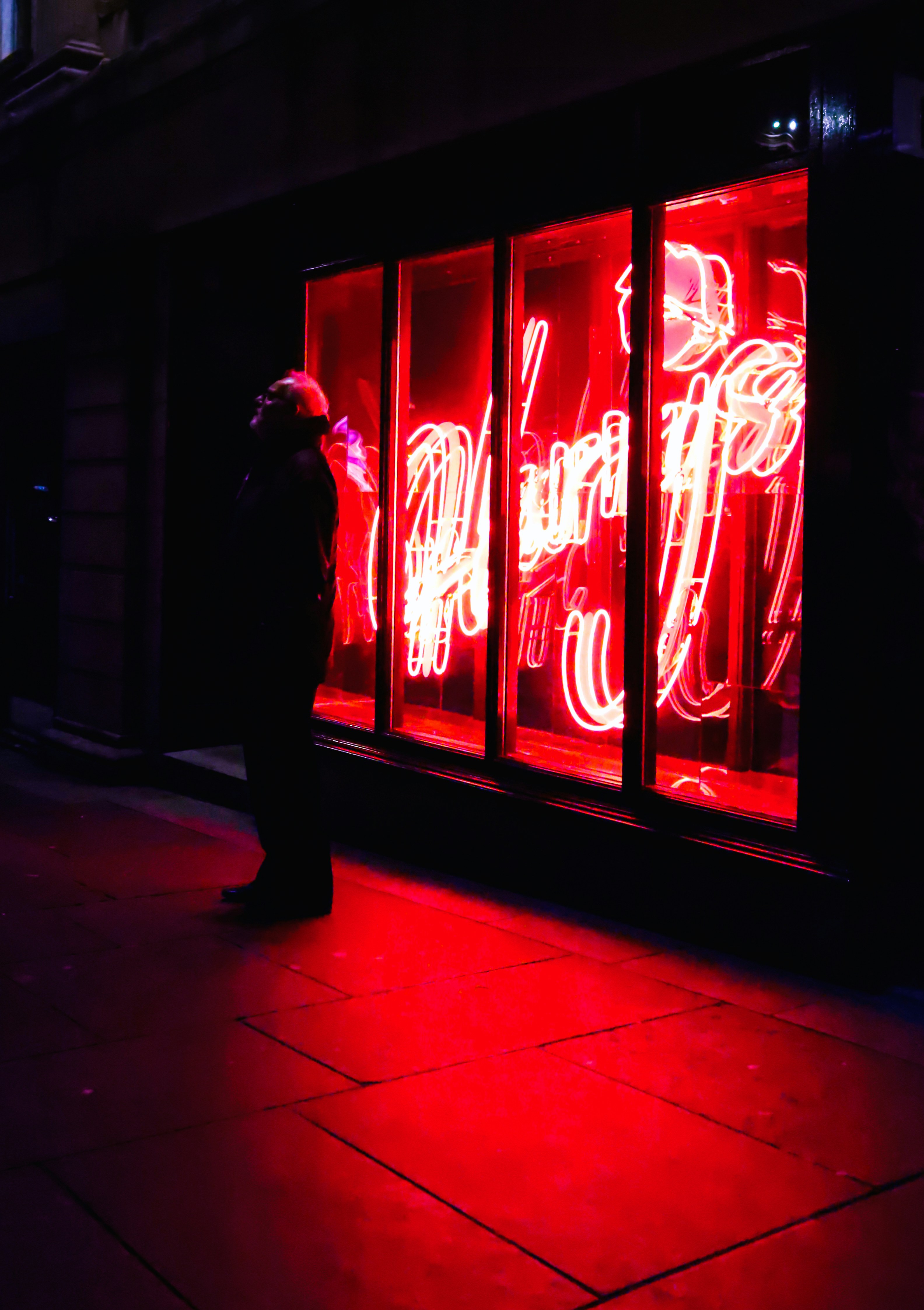 Crimson Neon Silhouette: Stillness by a Red Window