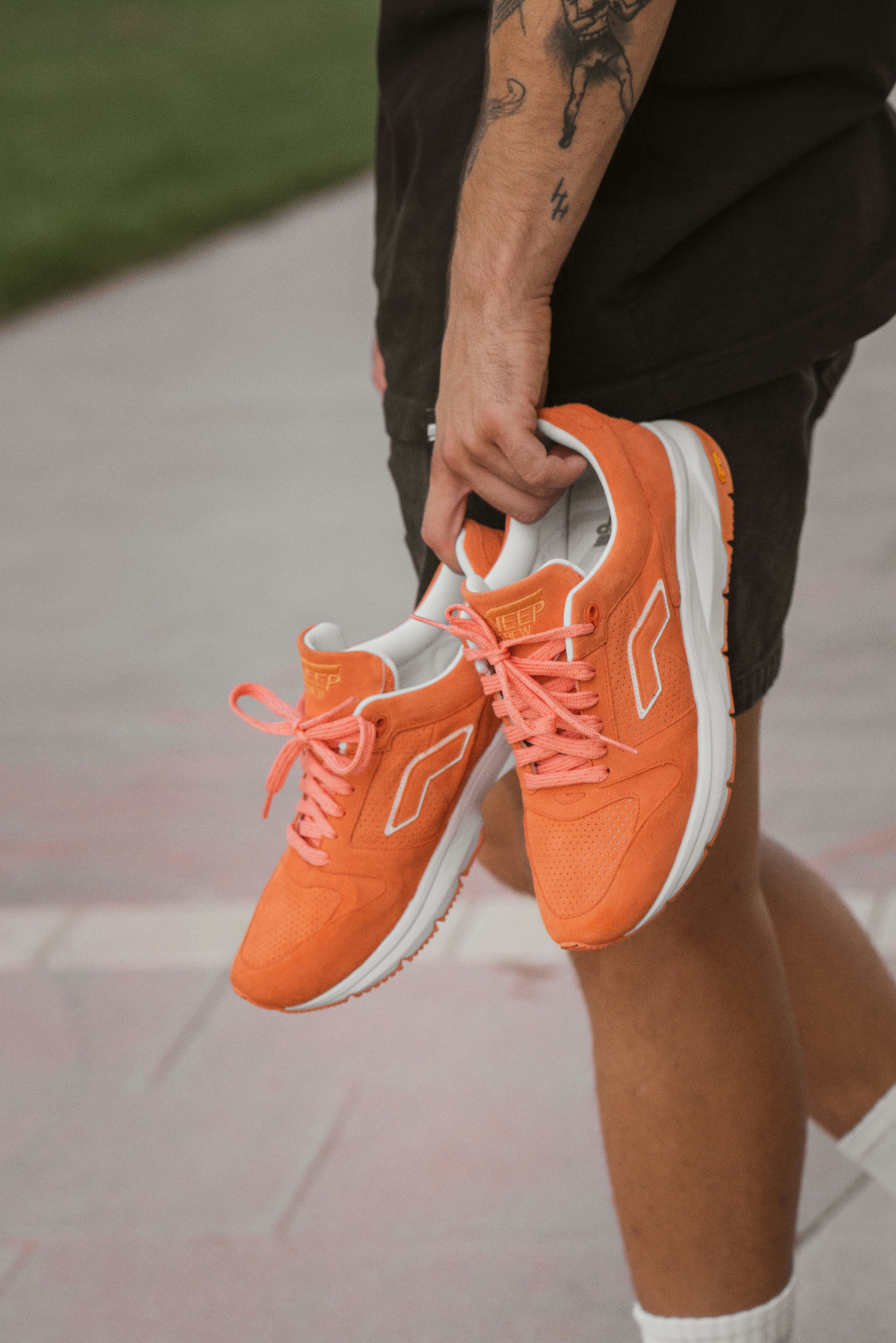 Orange Sneakers on Hold: A Street Moment