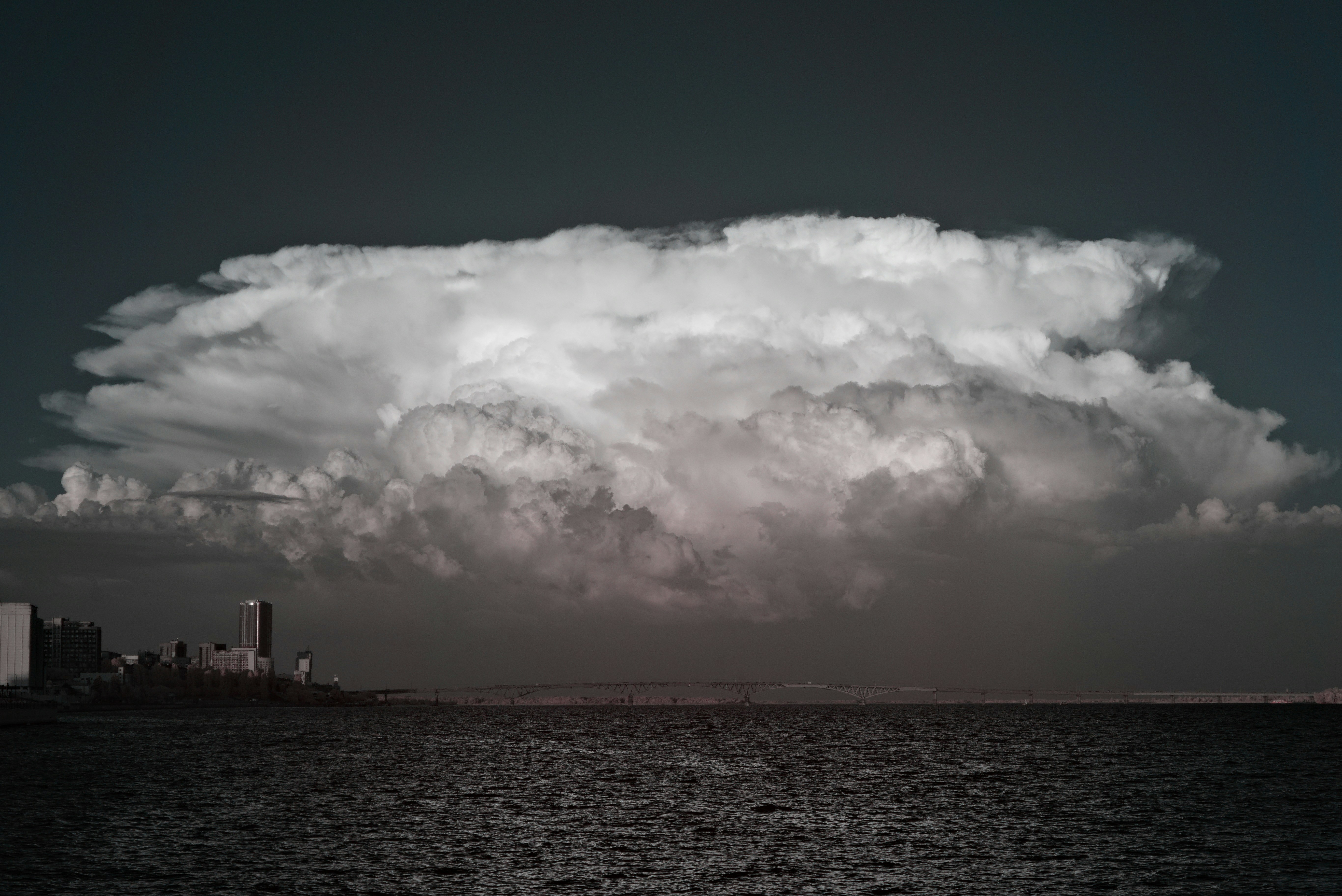 Cloud Fortress Over a Quiet Harbor at Dusk