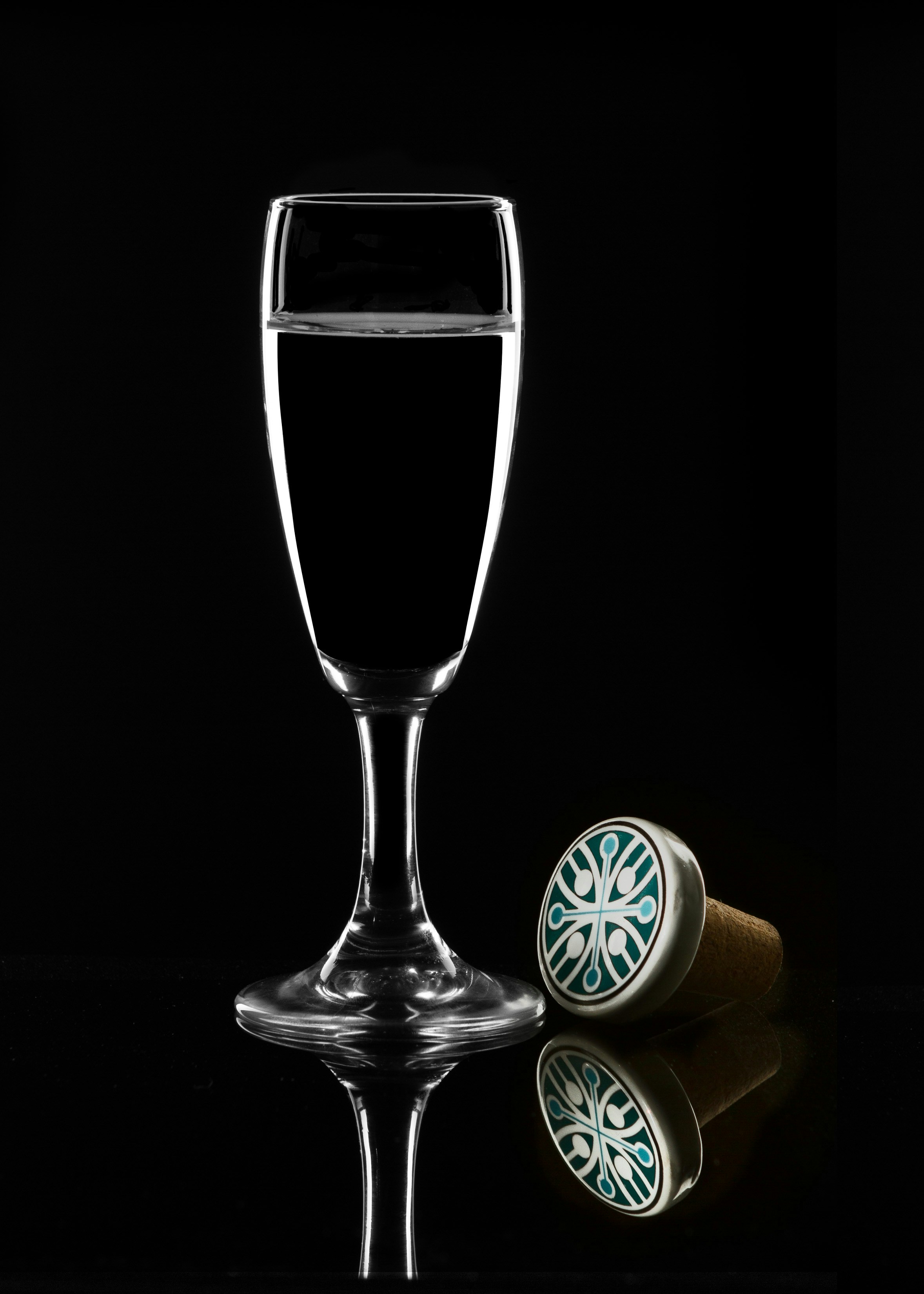 Stemware on black | clear wine glass with blue and white label