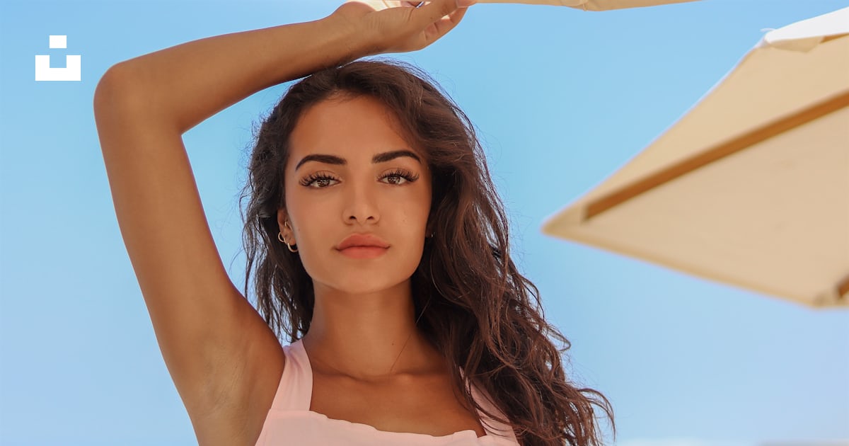 Woman In White Spaghetti Strap Top Holding Her Hair Photo Free