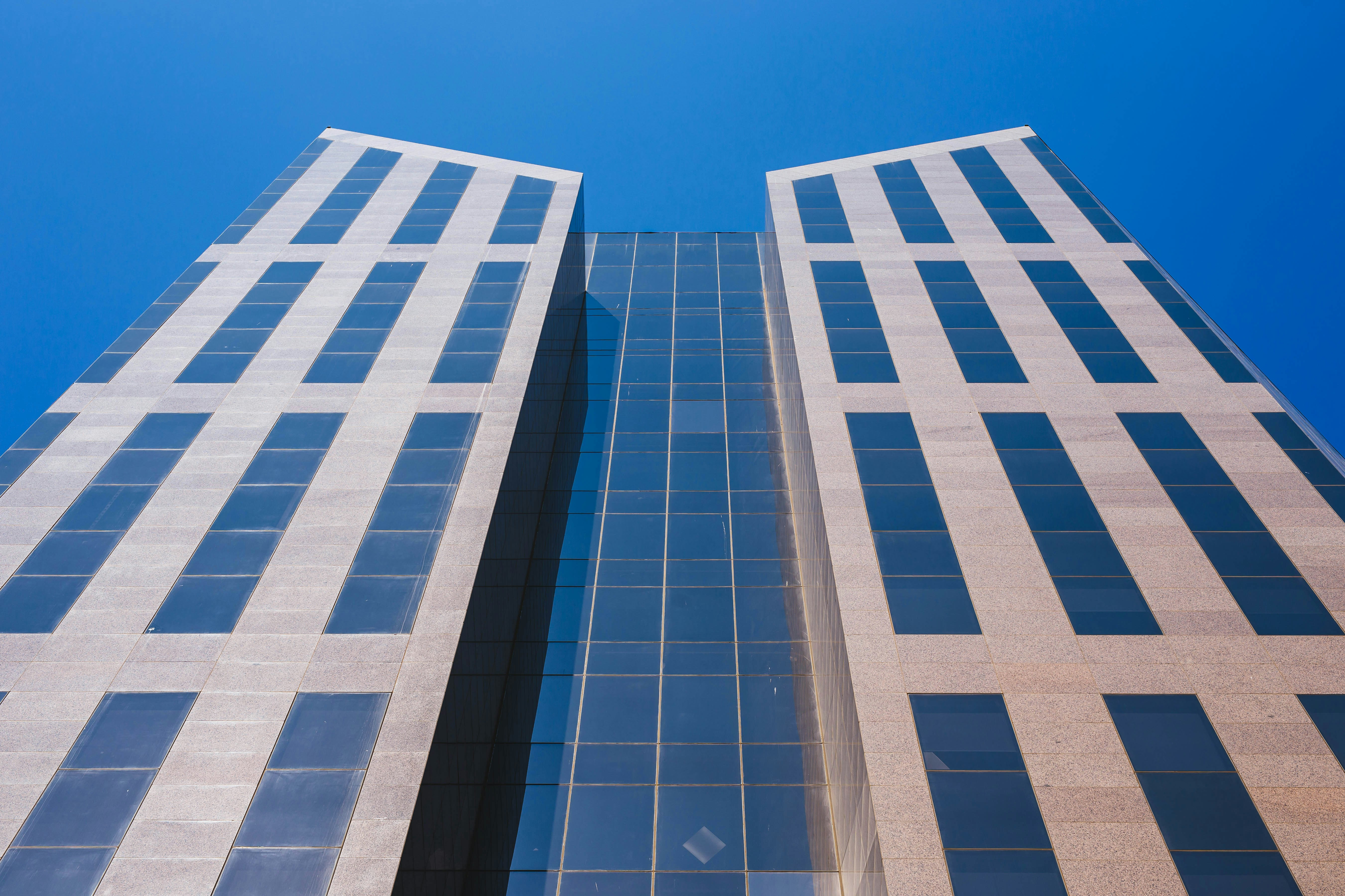 White and blue concrete building under blue sky during daytime photo ...