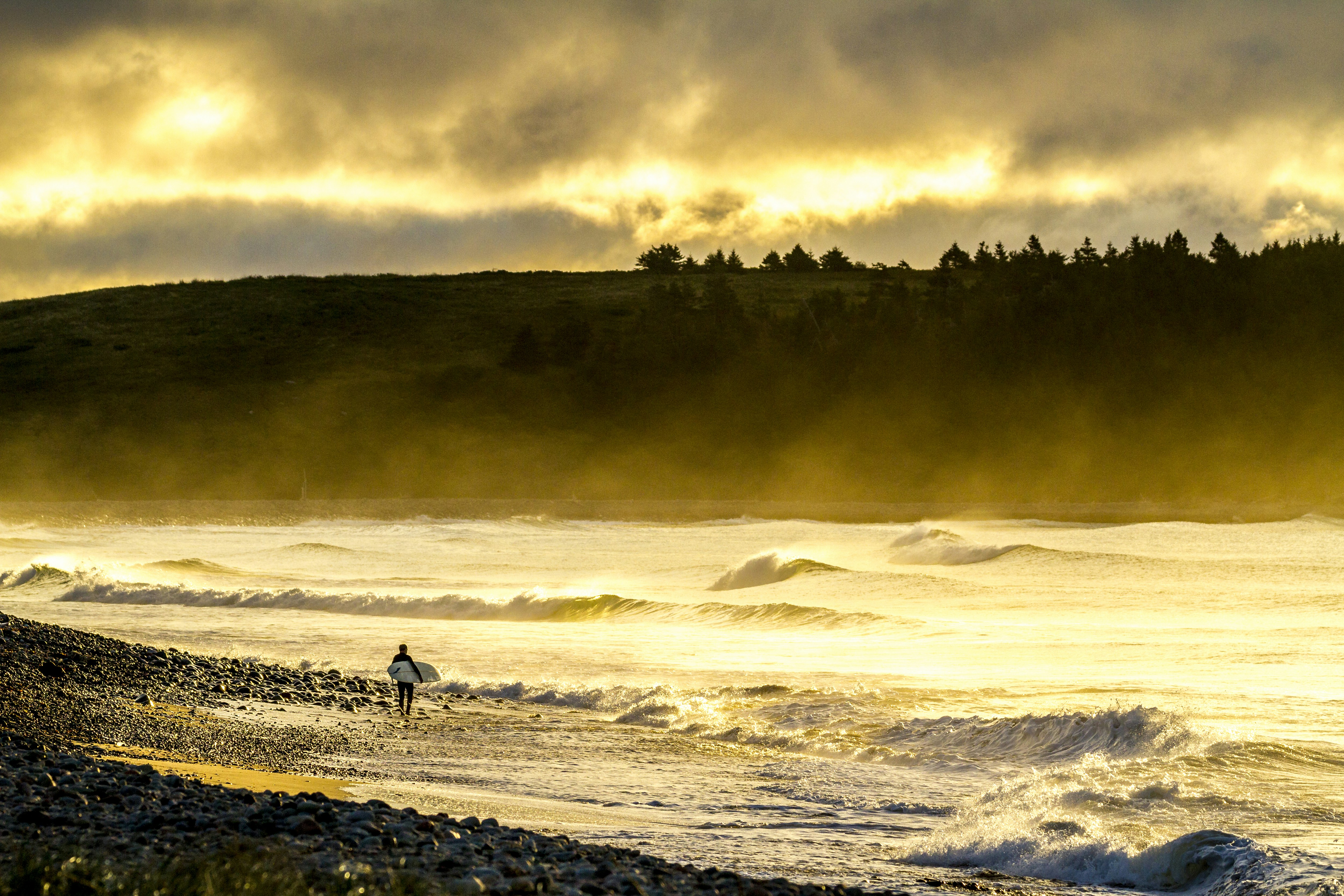 Single Surfer Echoes Along a Misty Dawn Shore