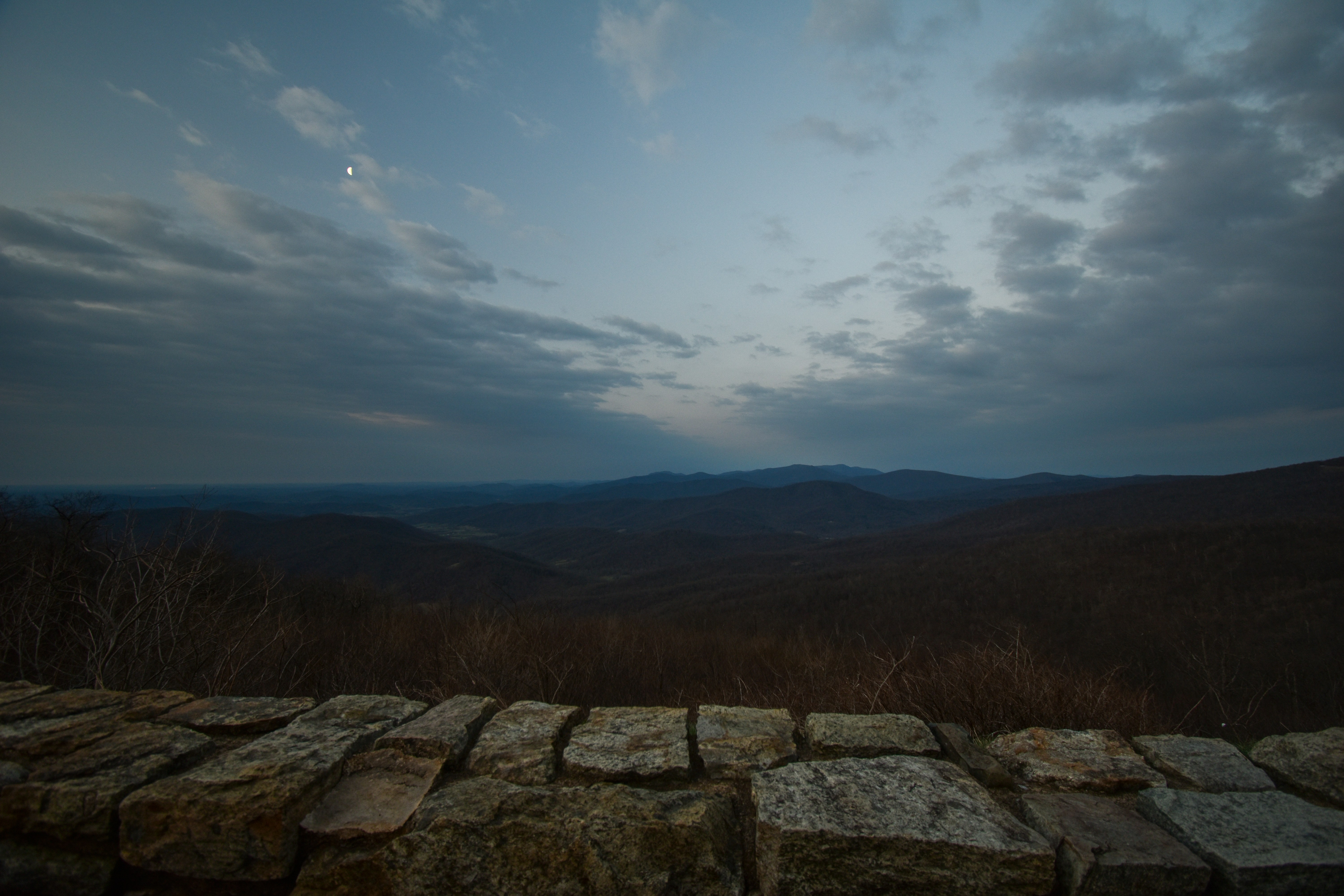 Moonlit Terrace Over a Dusk-Valley Stone Wall