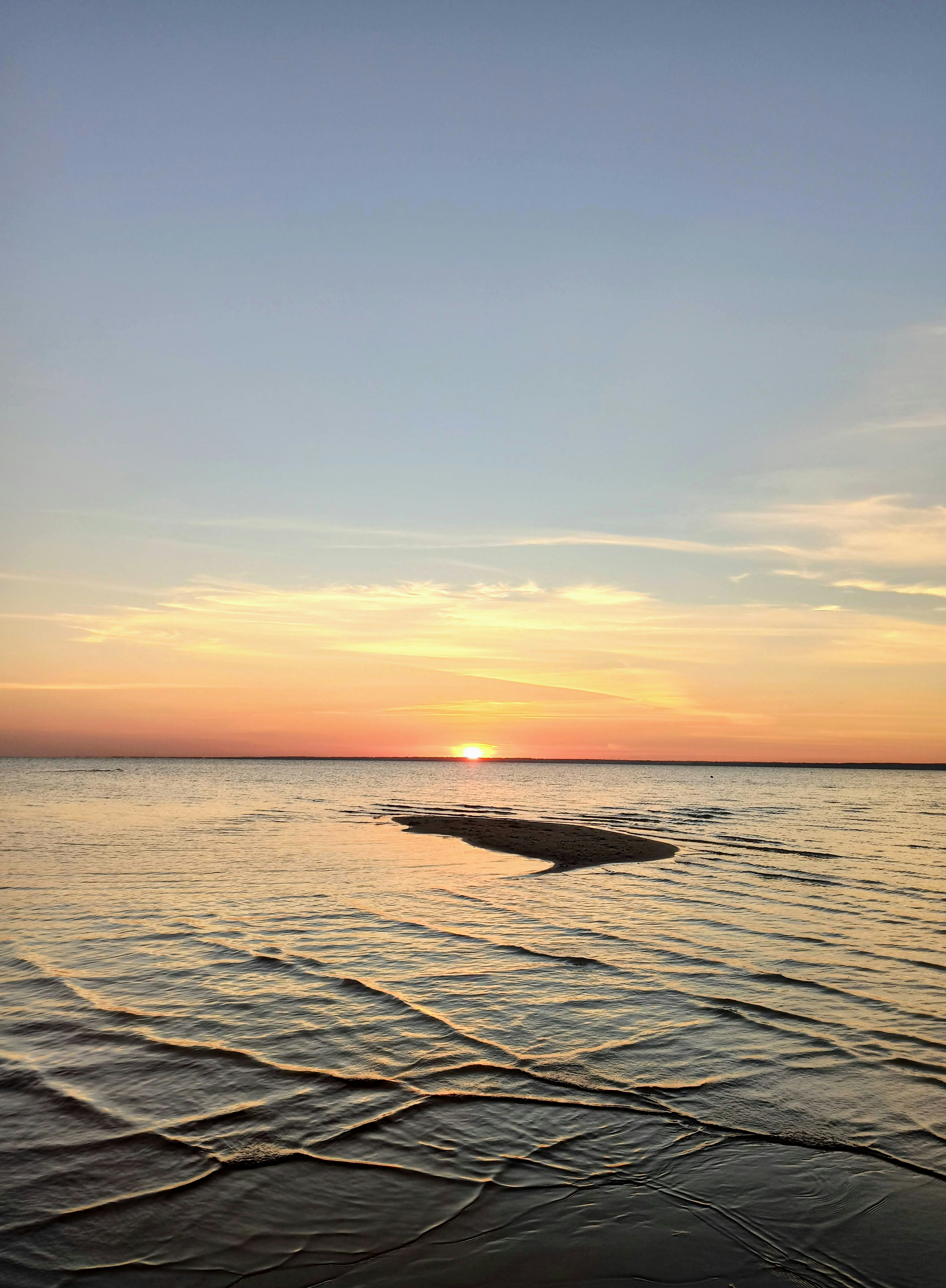 Sunset on a Ripple-Washed Tidal Flat: Quiet Horizon, Bright Light