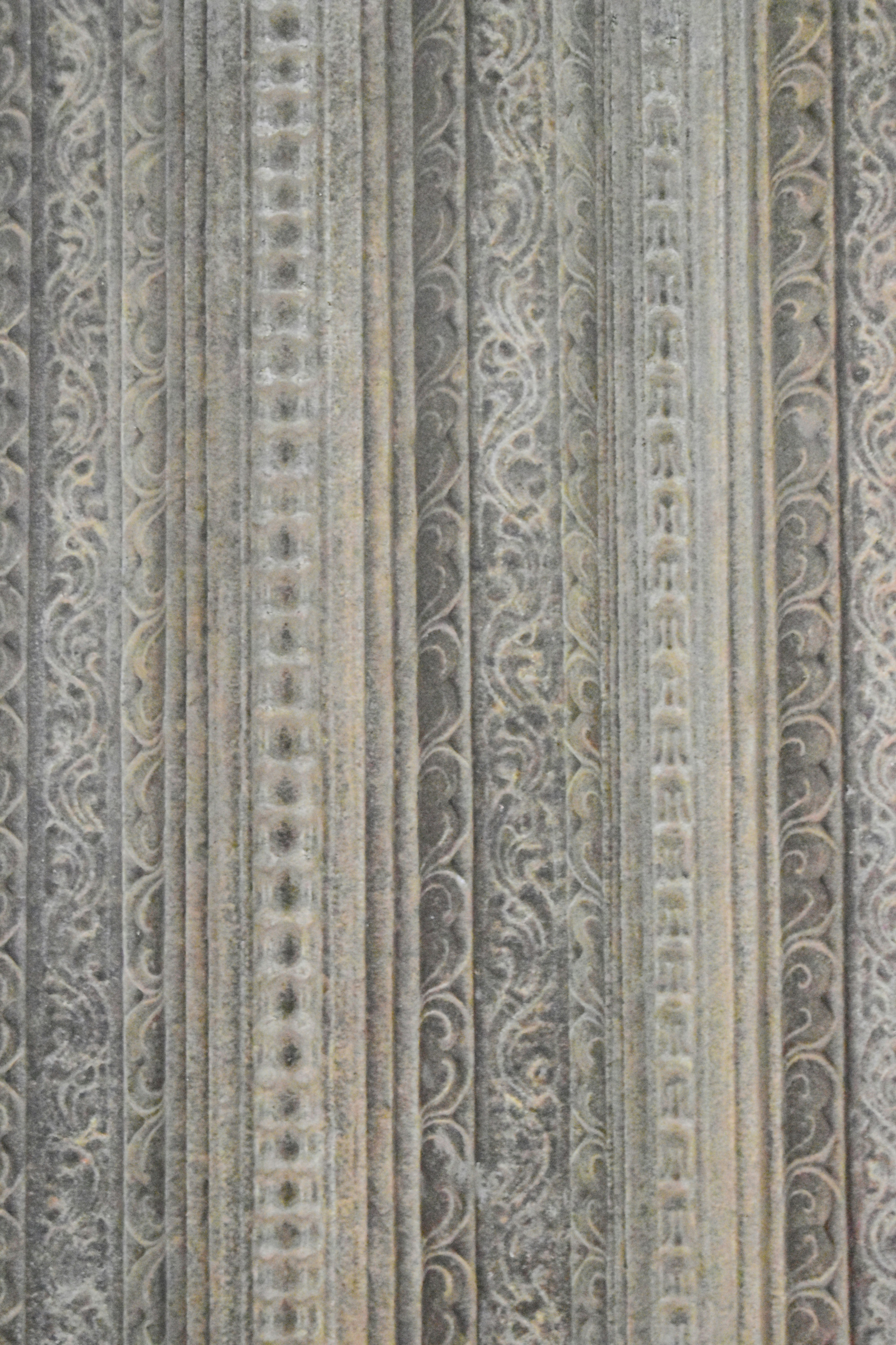 Close-up of ornate stone columns showcasing detailed carvings and patterns. The craftsmanship highlights the beauty of architectural design.