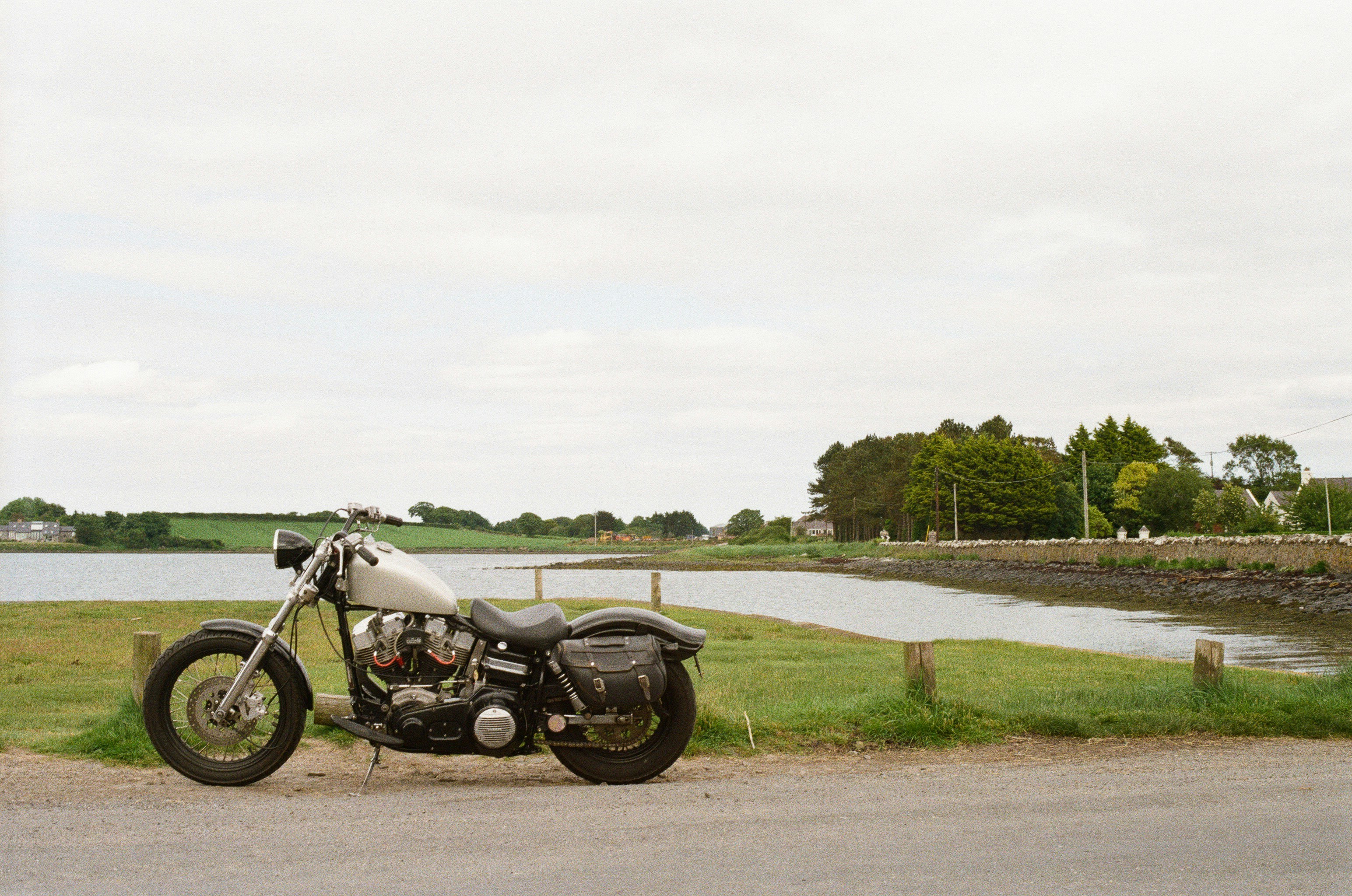 Black motorcycle parked on gray concrete road during daytime photo ...