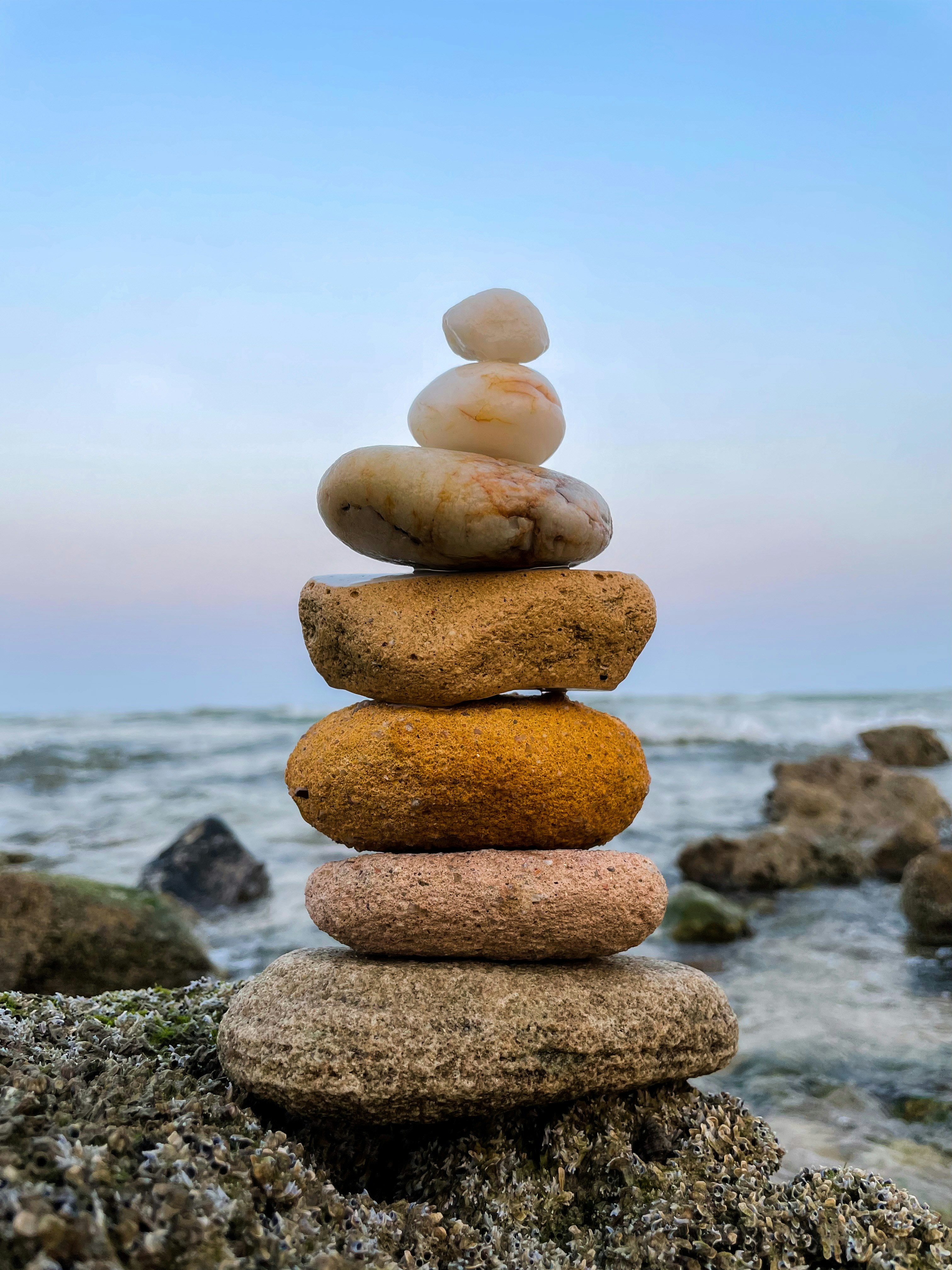 Stack of stones on rock near sea during daytime photo – Free Kuwait ...
