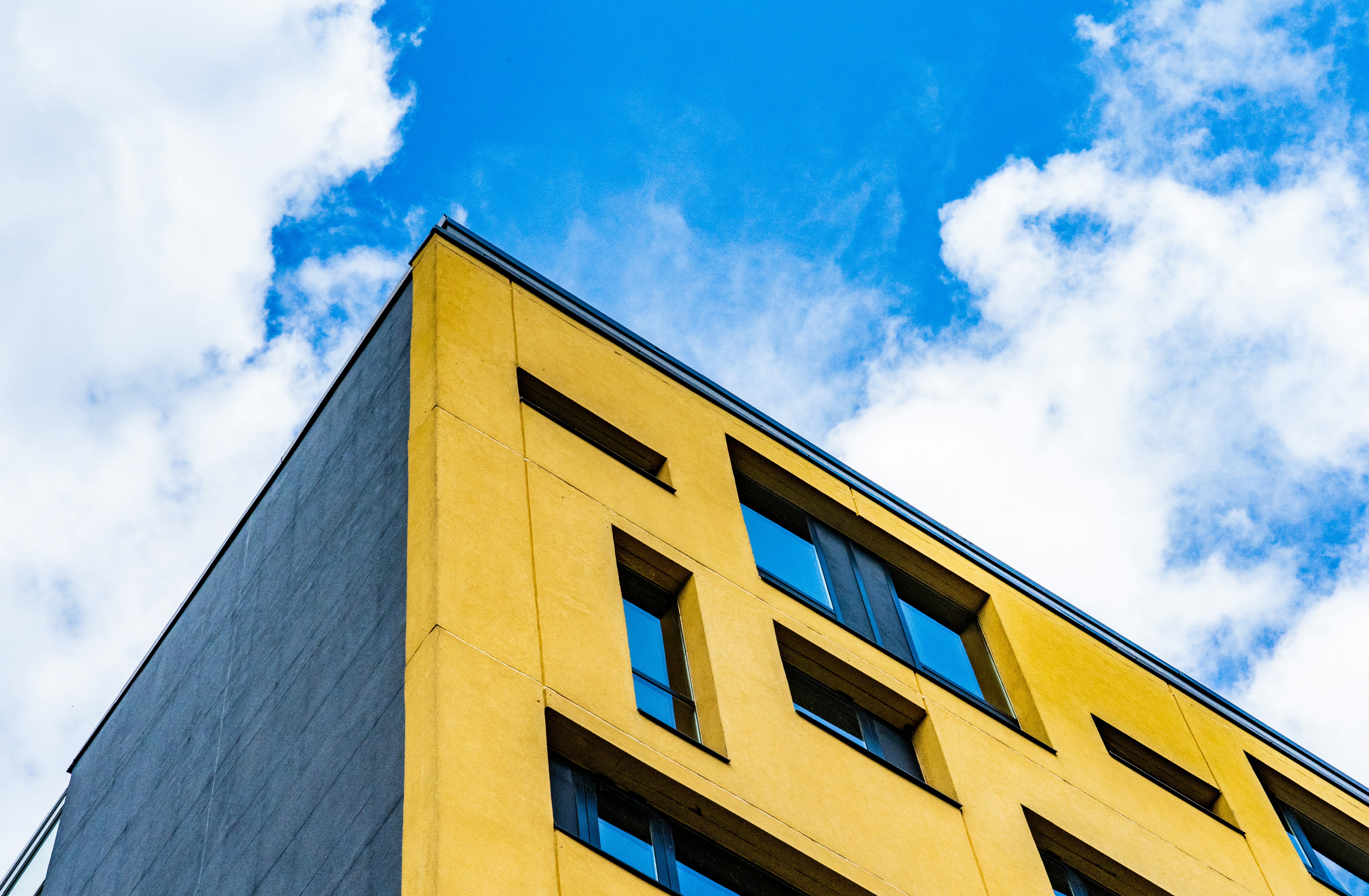 yellow building, blue sky | brown concrete building under blue sky during daytime