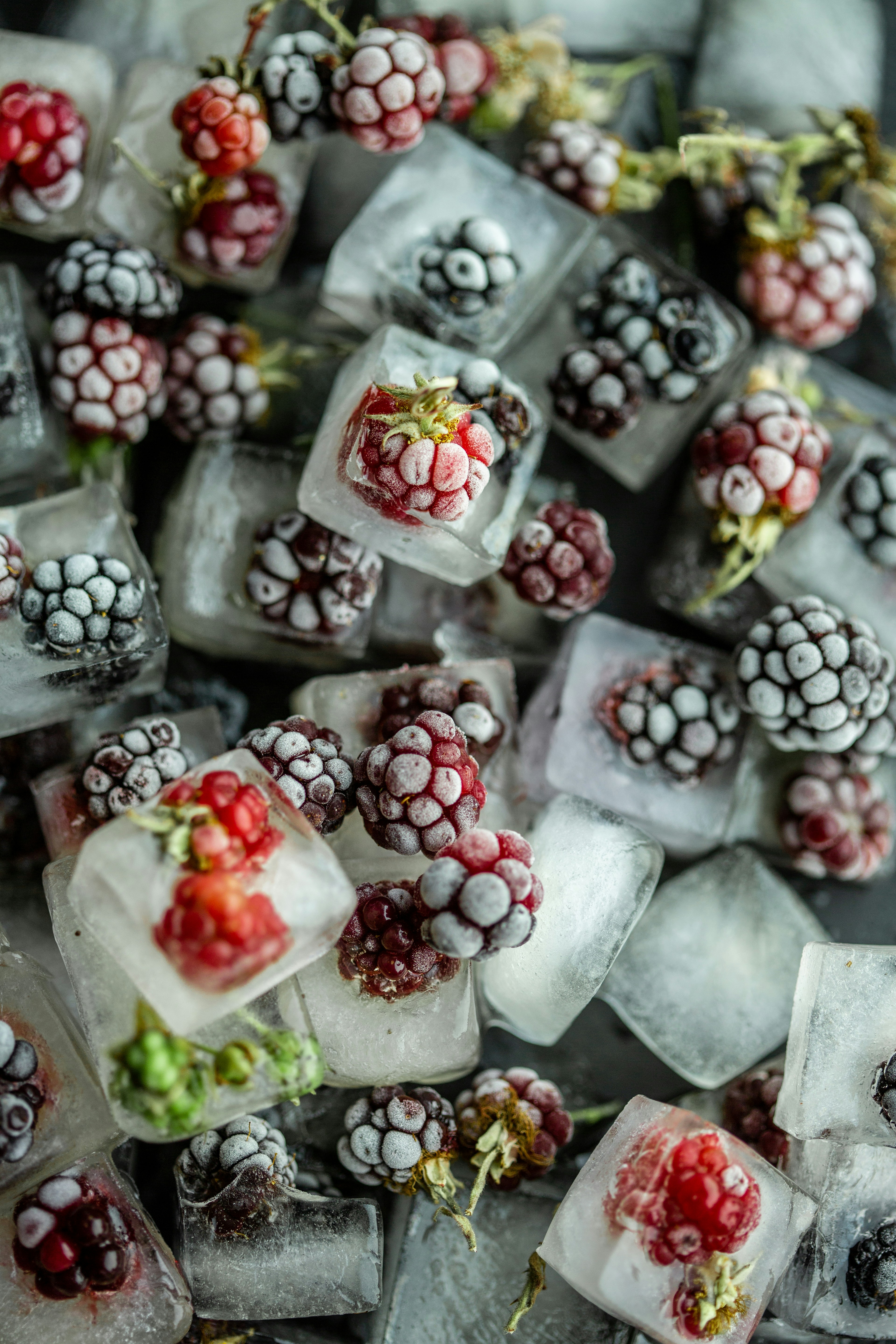 Frozen Berries in Ice Cubes: A Close-Up Quilt of Winter Color