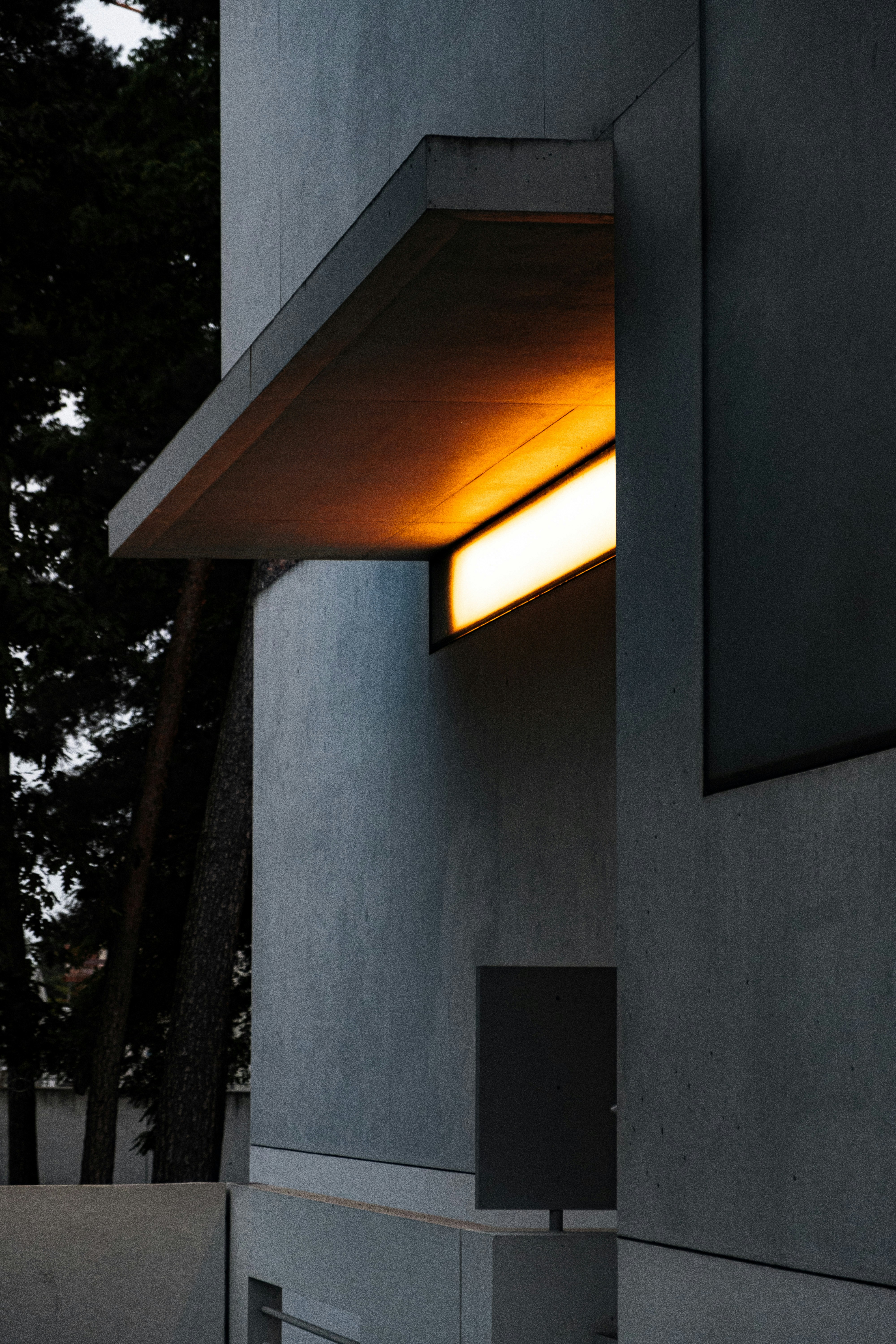 Underlit Corner: Warm Glow on Brutalist Facade