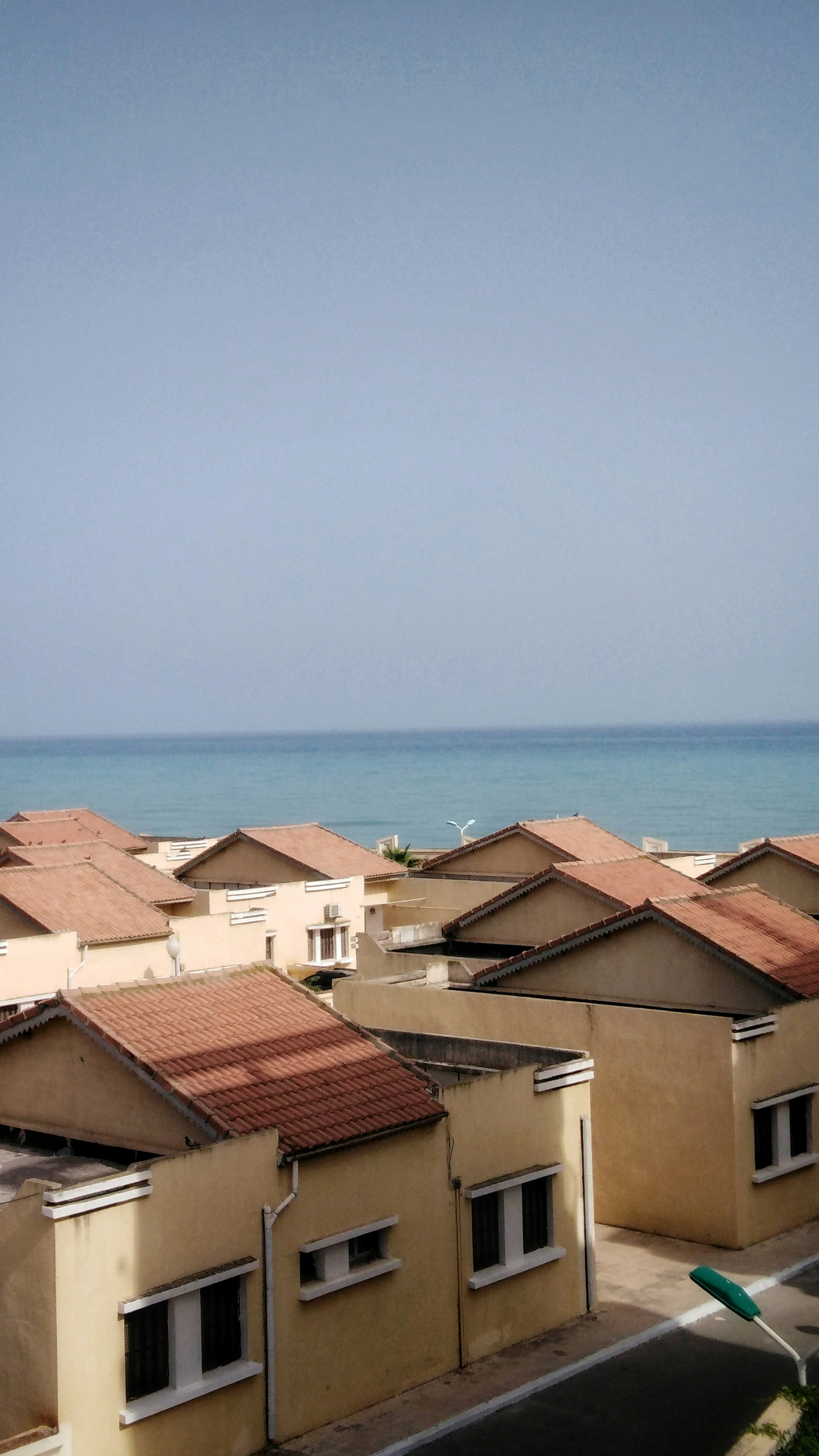 Sunlit Courtyard Rooftops Lean Toward the Sea