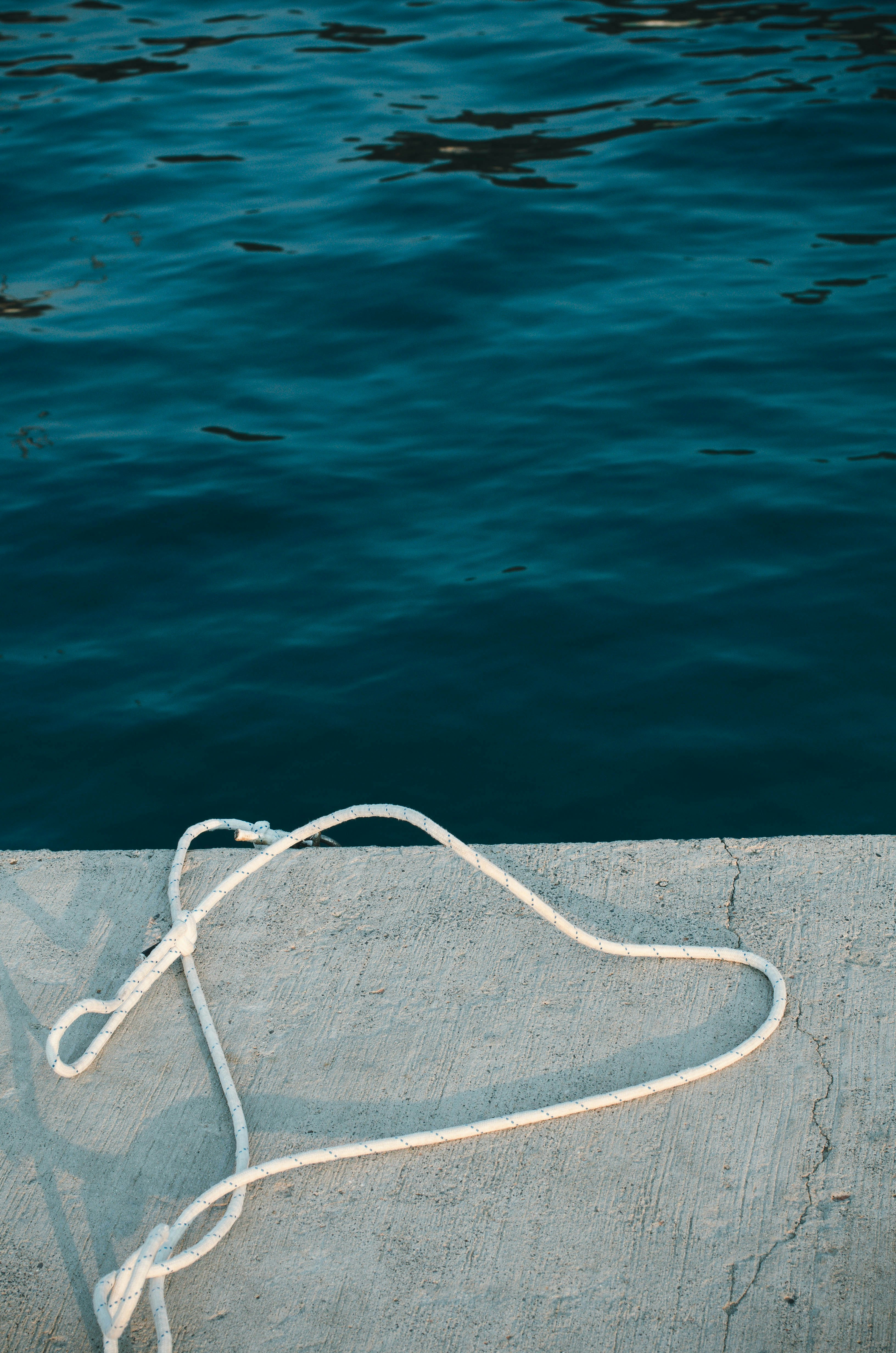 white rope on gray concrete surface