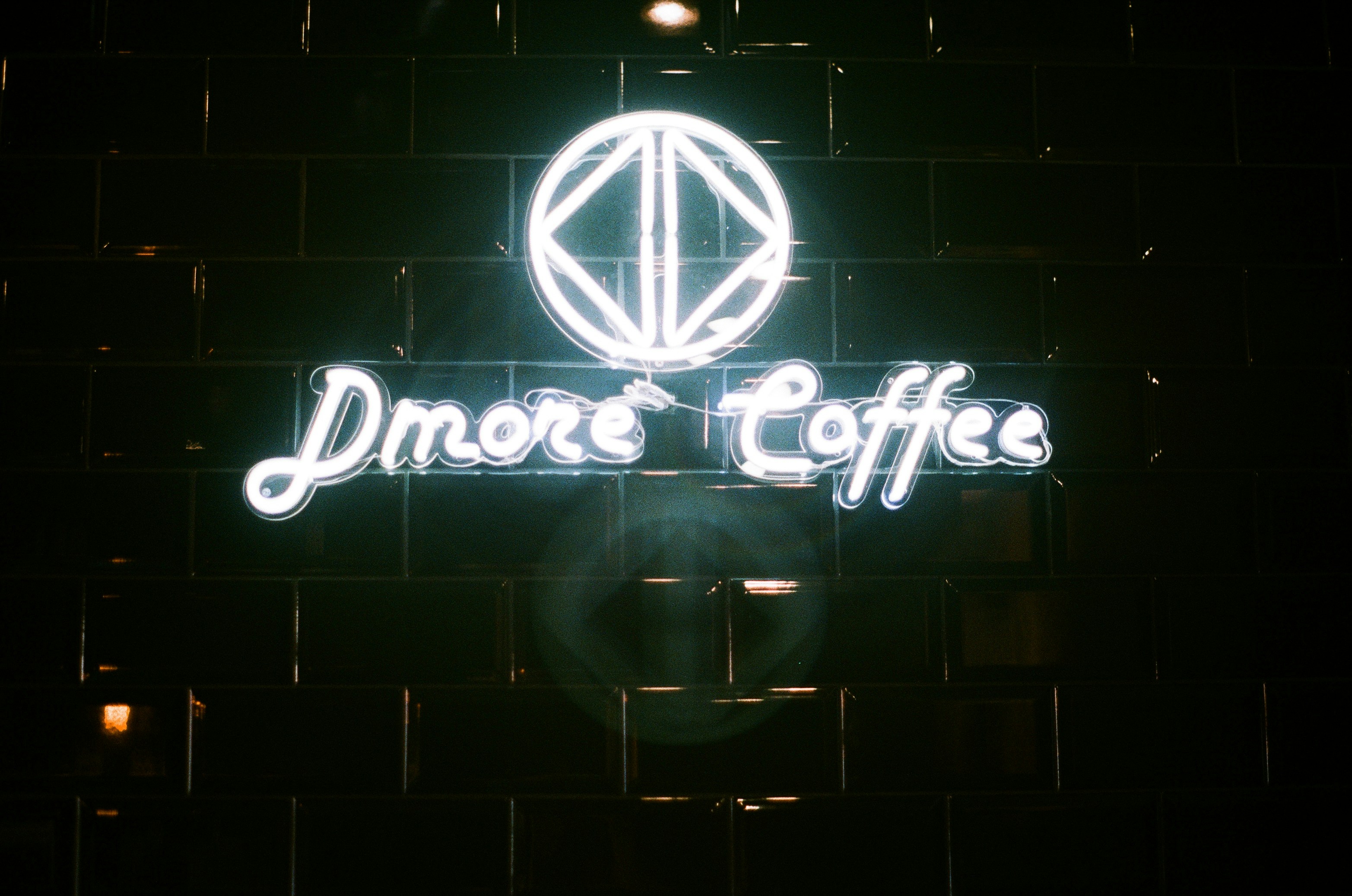A neon sign that reads jones'coffee on a brick wall photo – Free Light ...