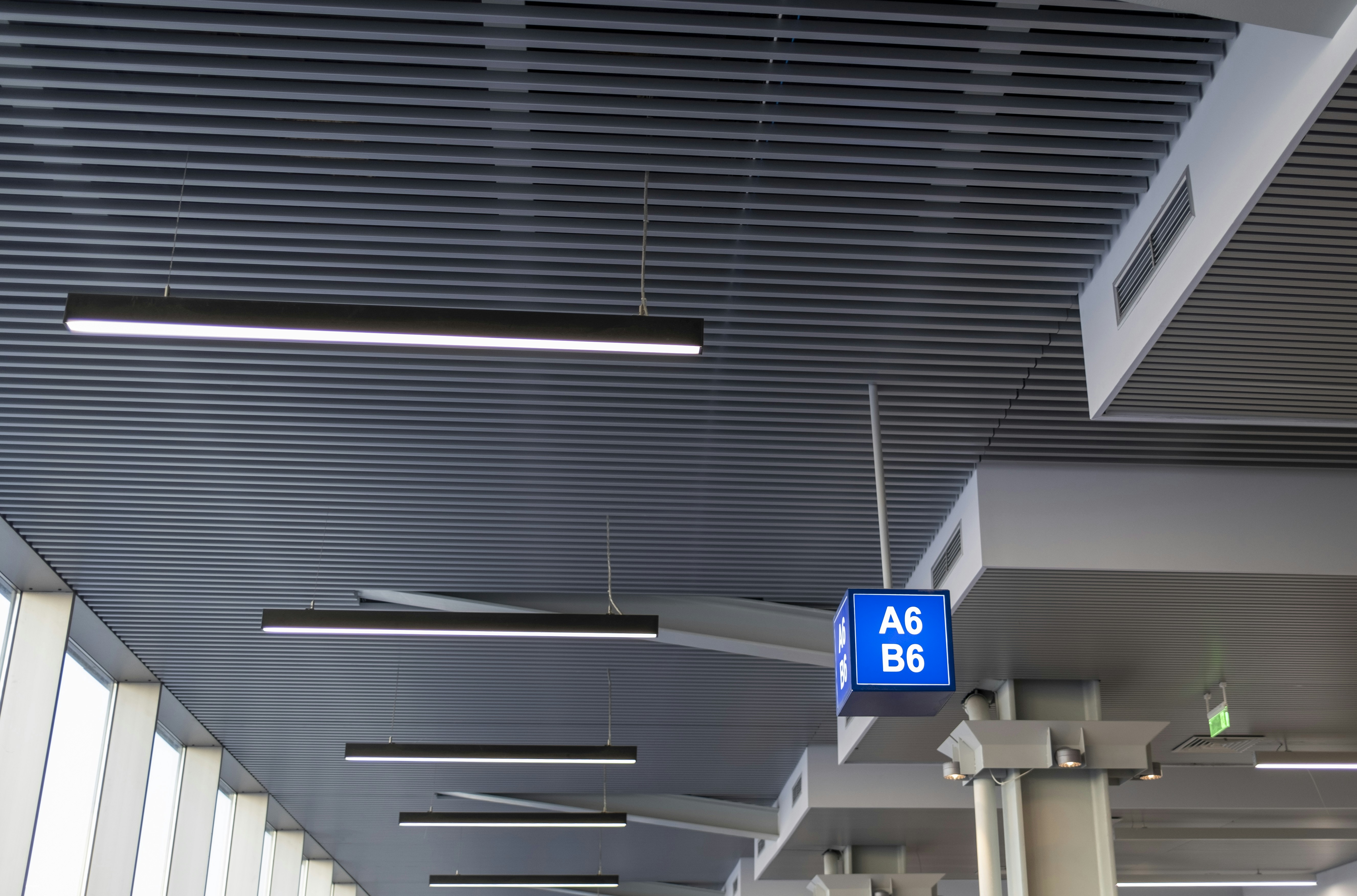 Blue Gate Sign in Modern Airport Corridor