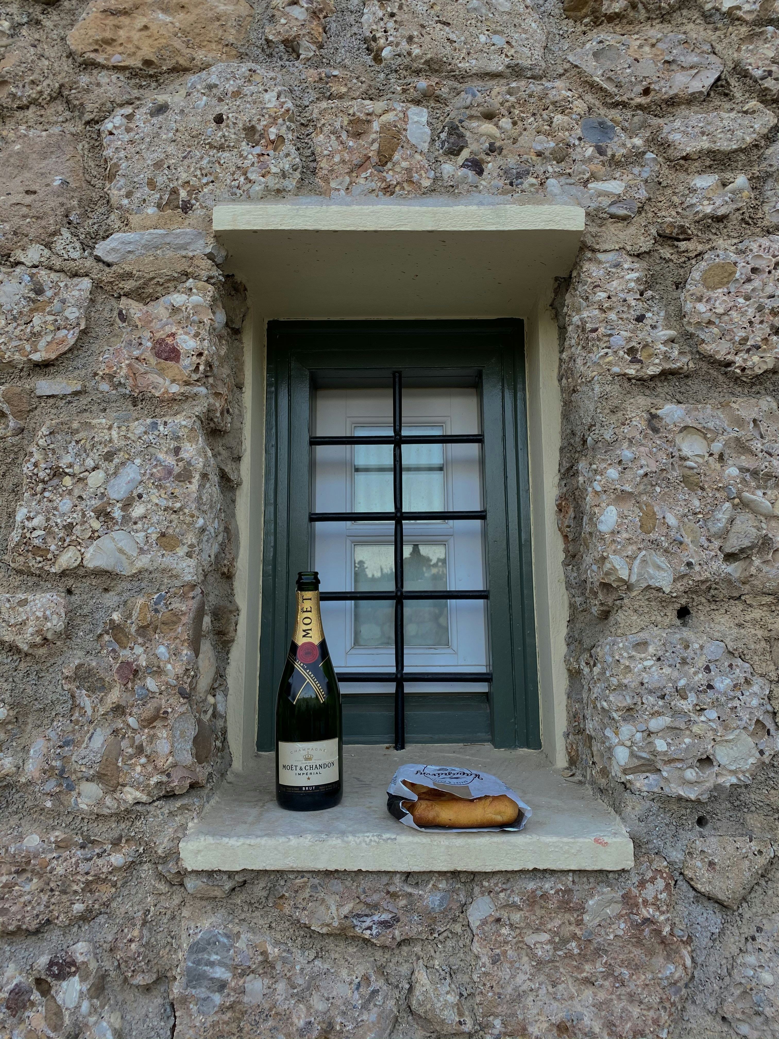 A Quiet Toast: Bottle and Pastry Rest in a Stone Window Niche
