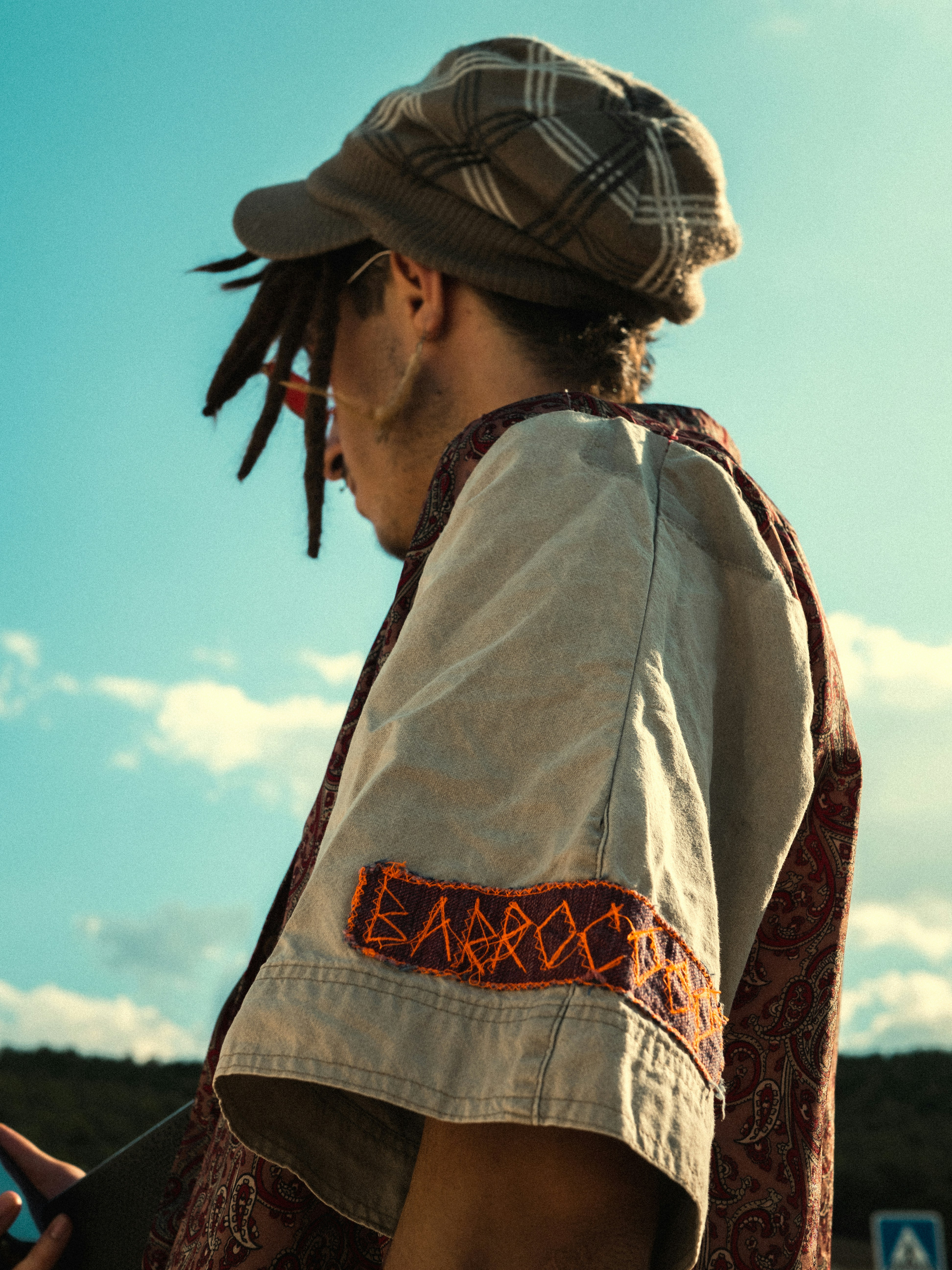 Portrait of a Nomad: Side profile under a cotton sky