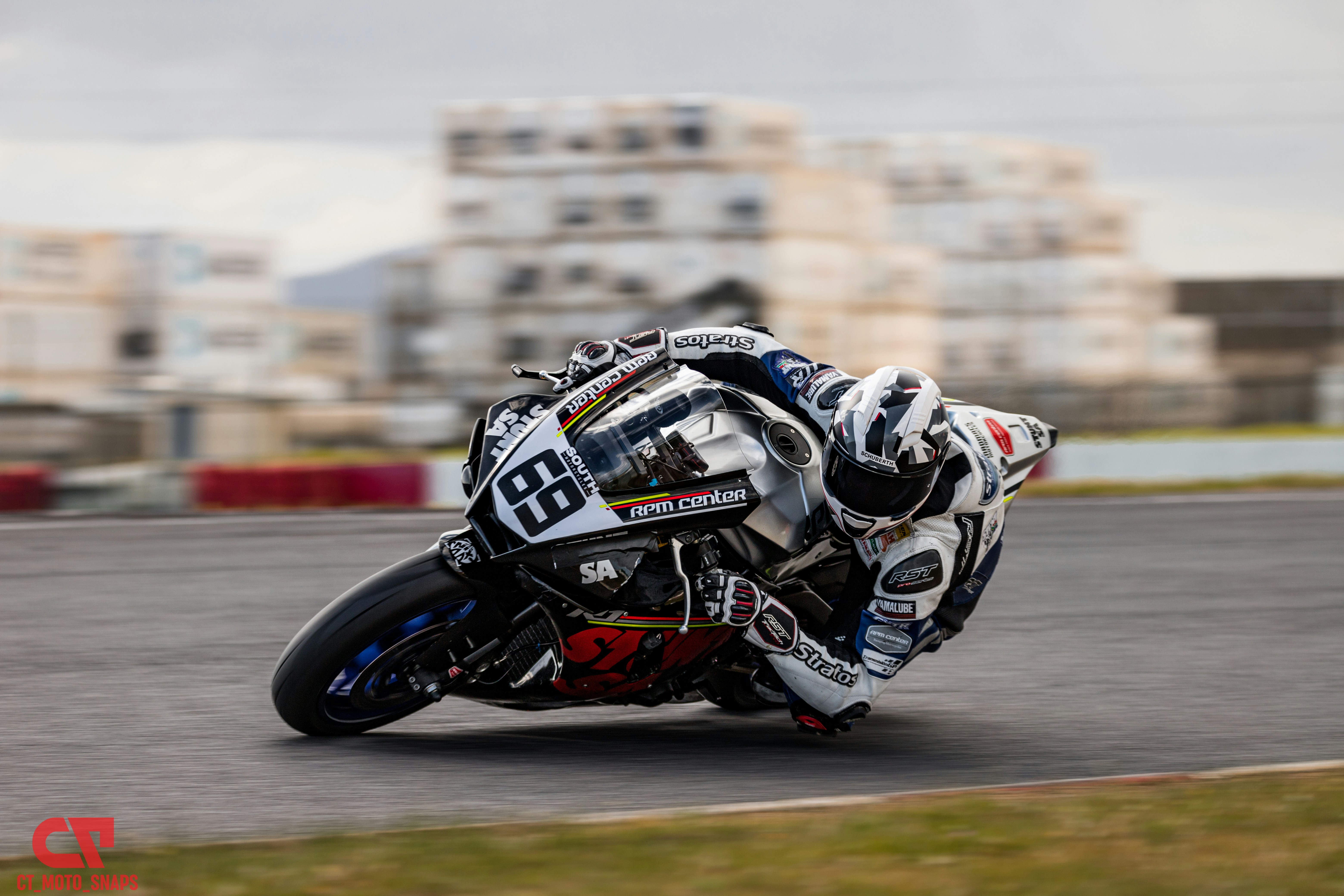 Man in blue and white motorcycle suit riding on black and white sports ...