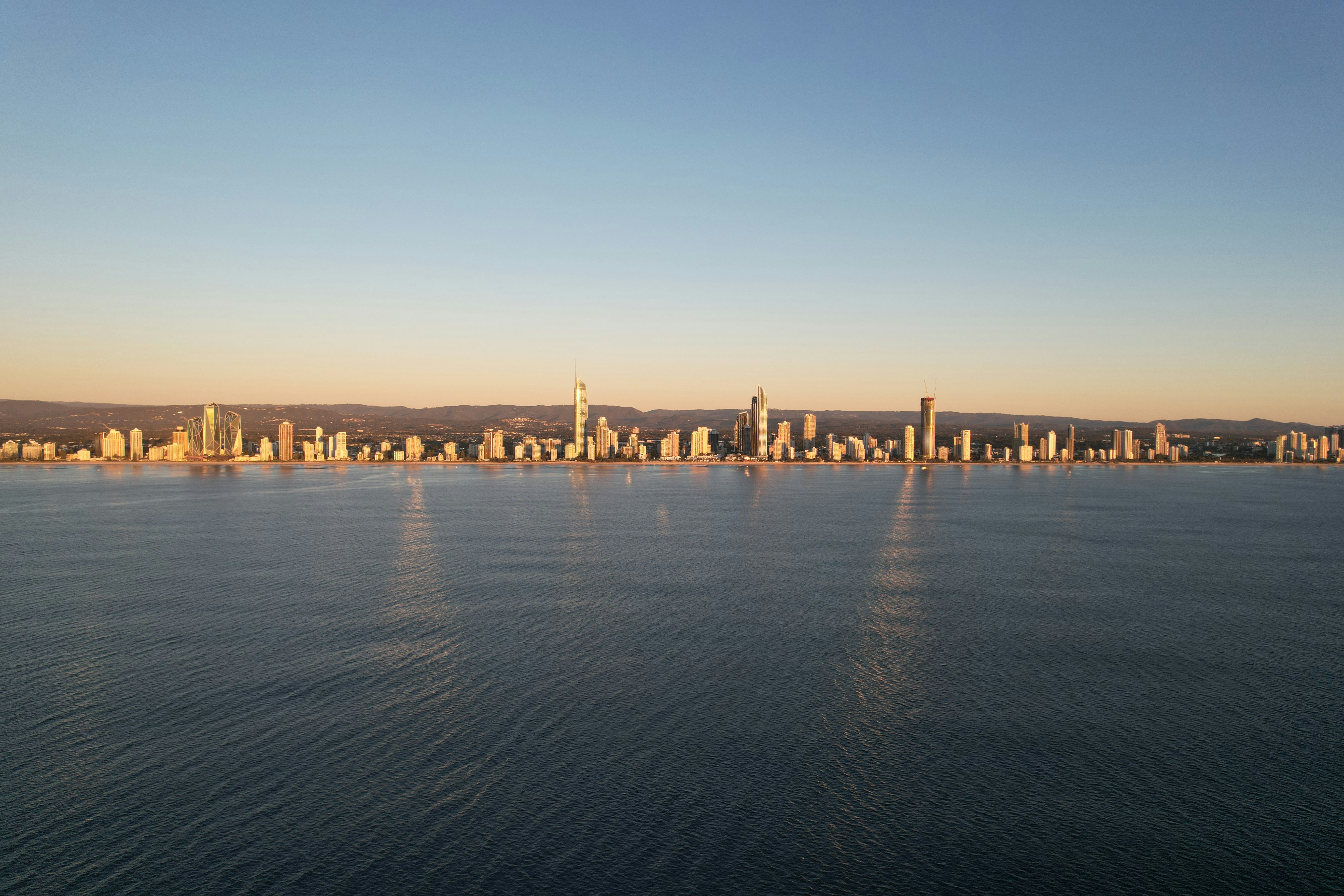 Dawn Rise Over a Calm Harbor: City Line at the Edge of Water