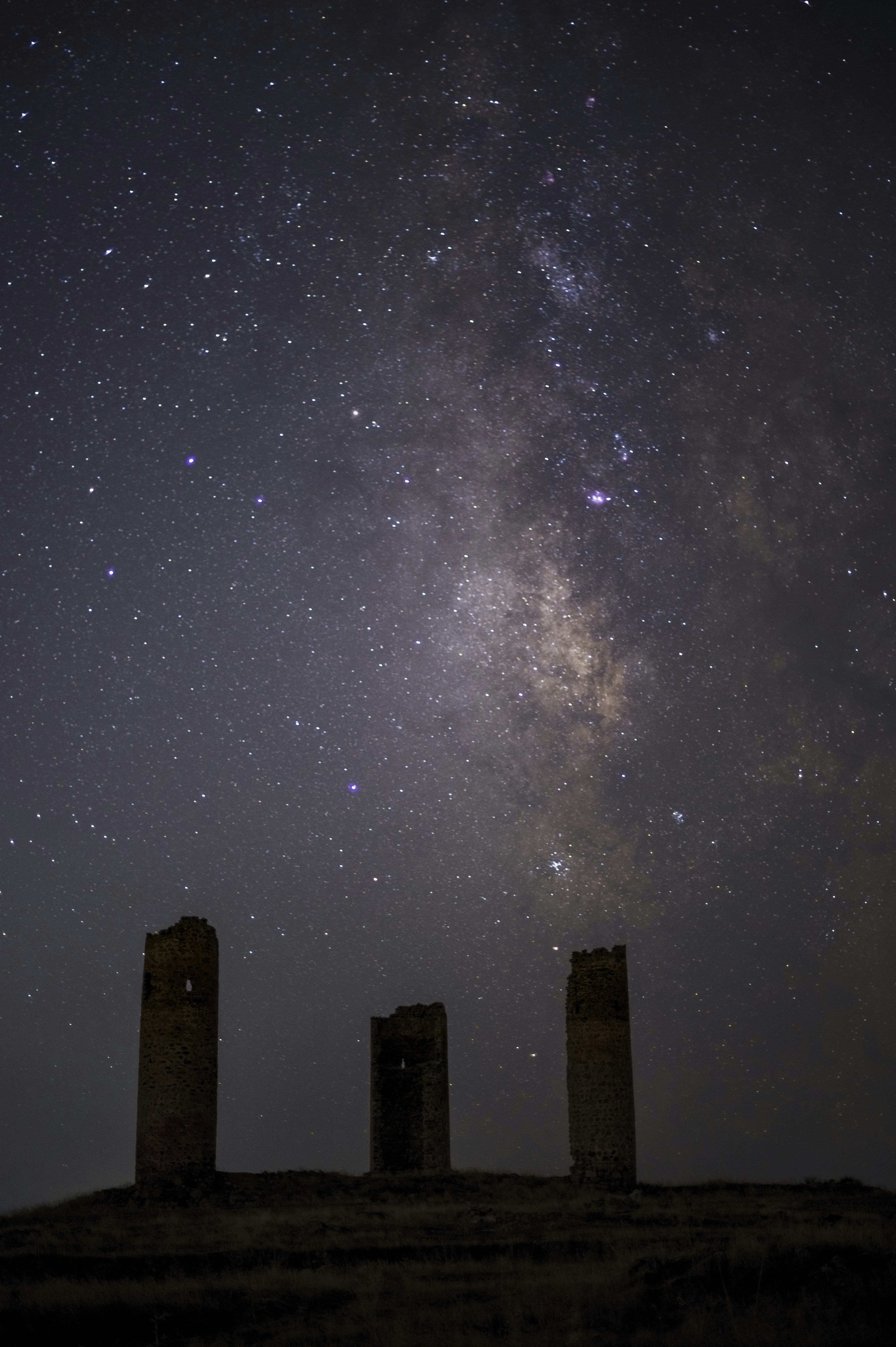 silhouette of high rise building under starry night