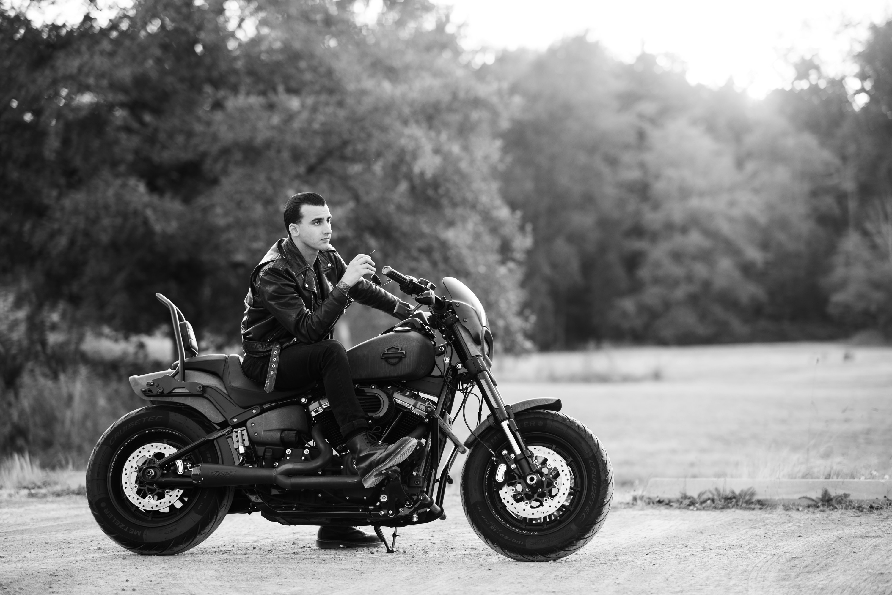 Grayscale Glide: Solitary Rider on a Dusty Road