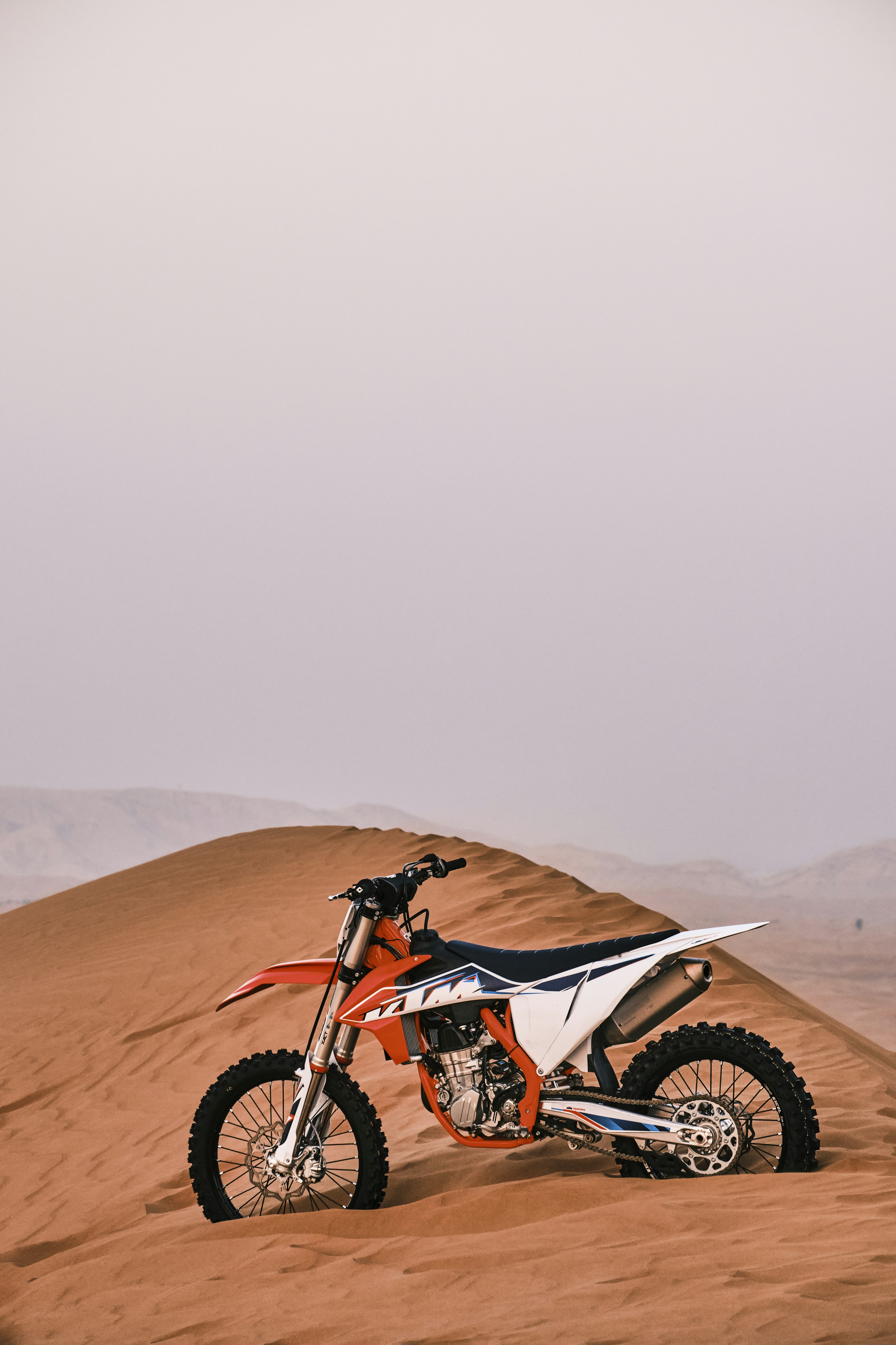 Red and black motocross dirt bike on brown sand photo – Free Dubai ...