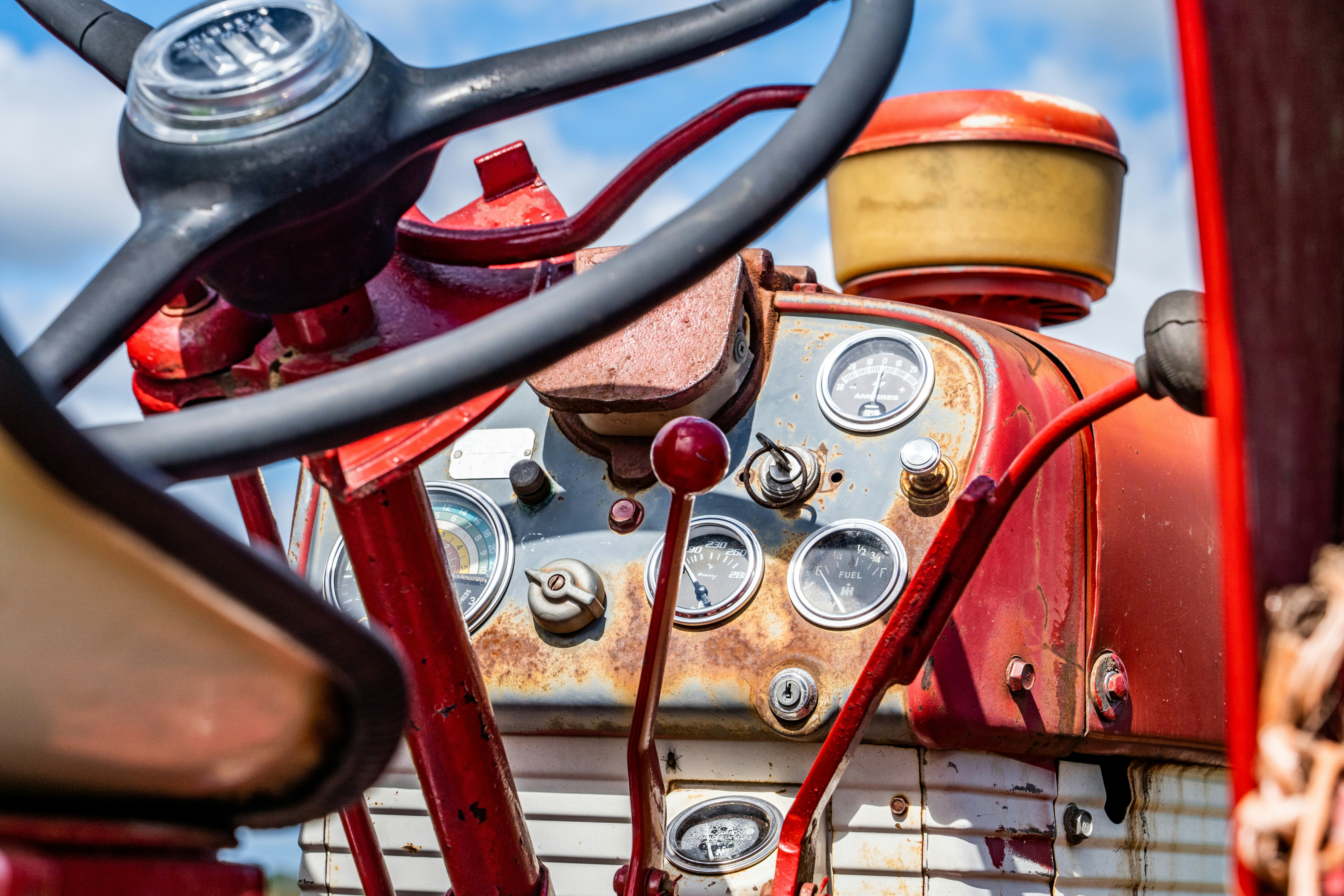 Rust-Red Cockpit: Close-Up of a Vintage Tractor Dashboard