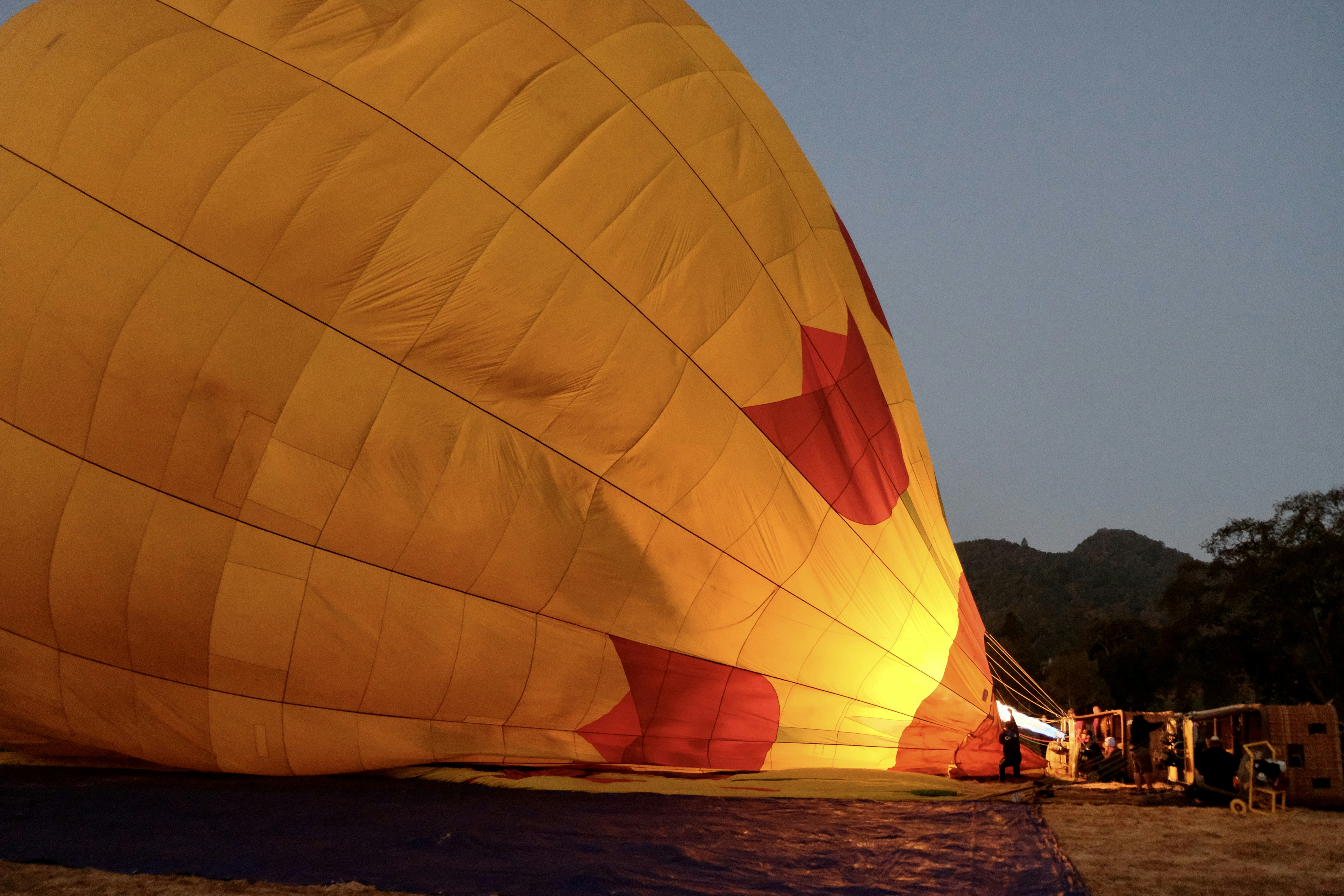Golden Envelope Resting on Desert Light: A Balloon Unfolds at Dusk