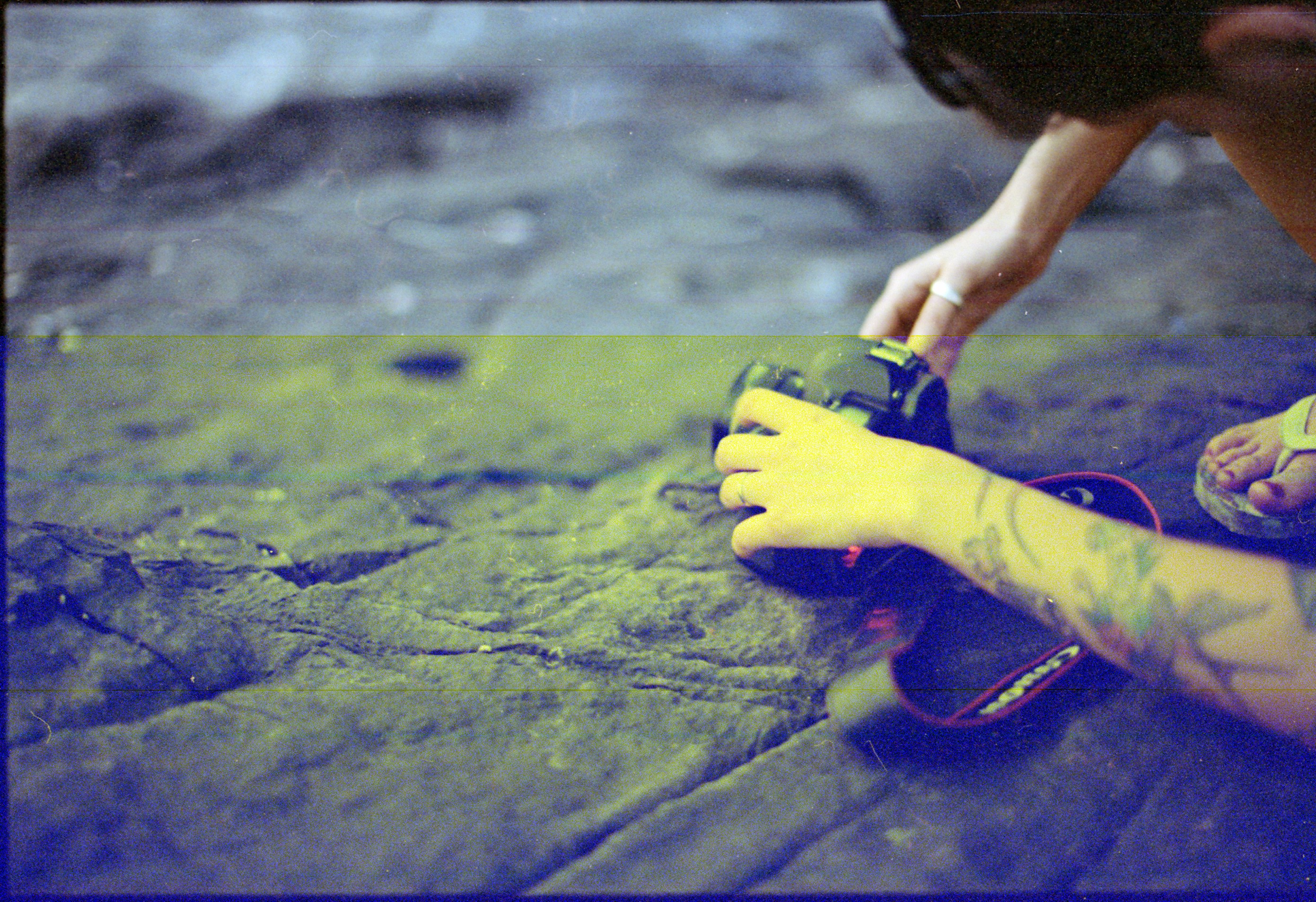 Hands on a Shaded Lens: A Casual Moment with a Vintage Grip