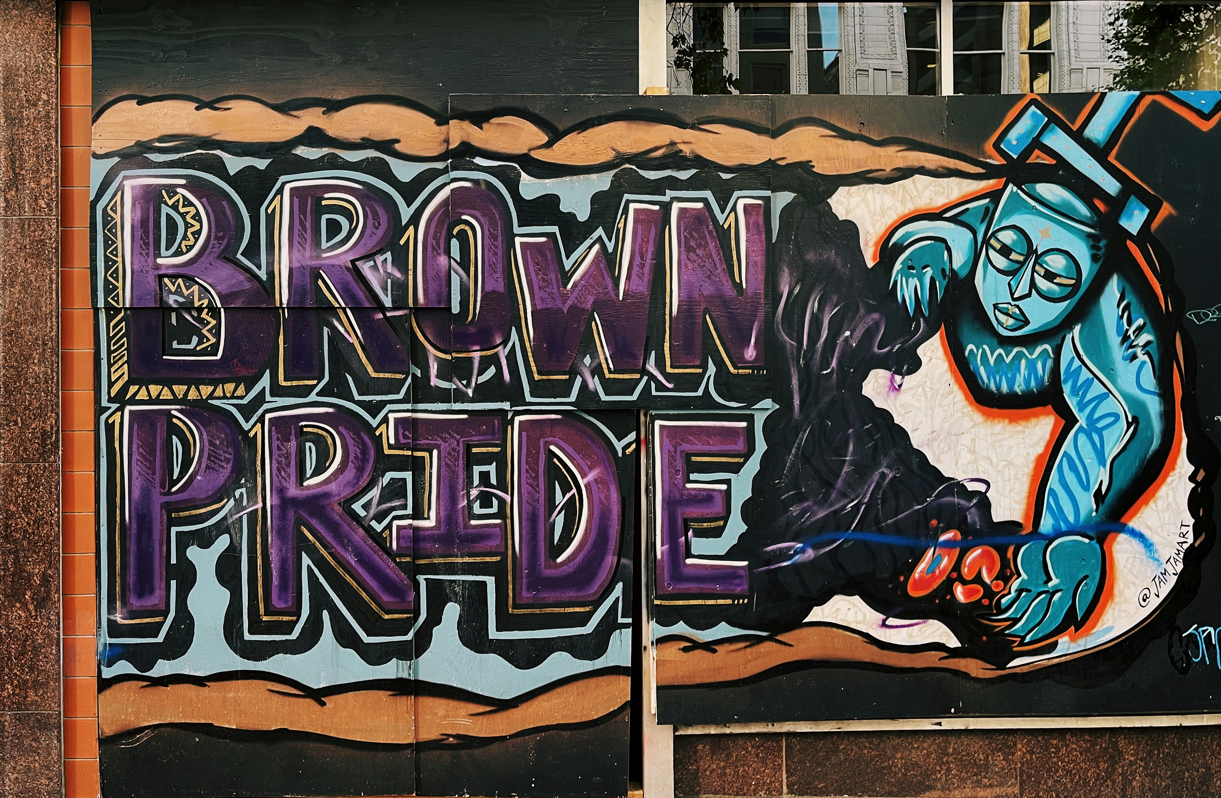 Bold Letters and a Blue Figure: Street Art in Full Color