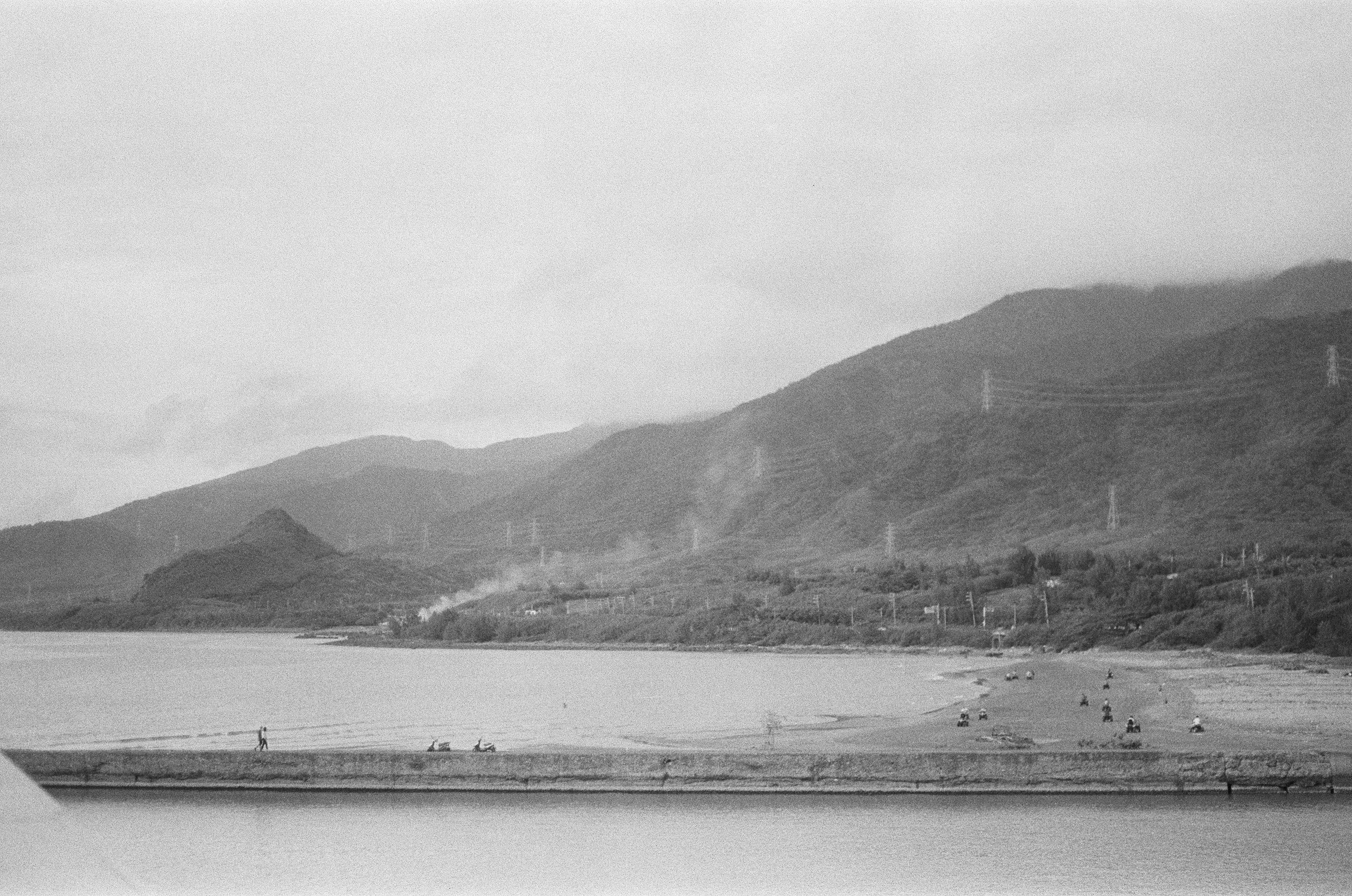 Grayscale photo of mountain near body of water photo – Free Grey Image ...